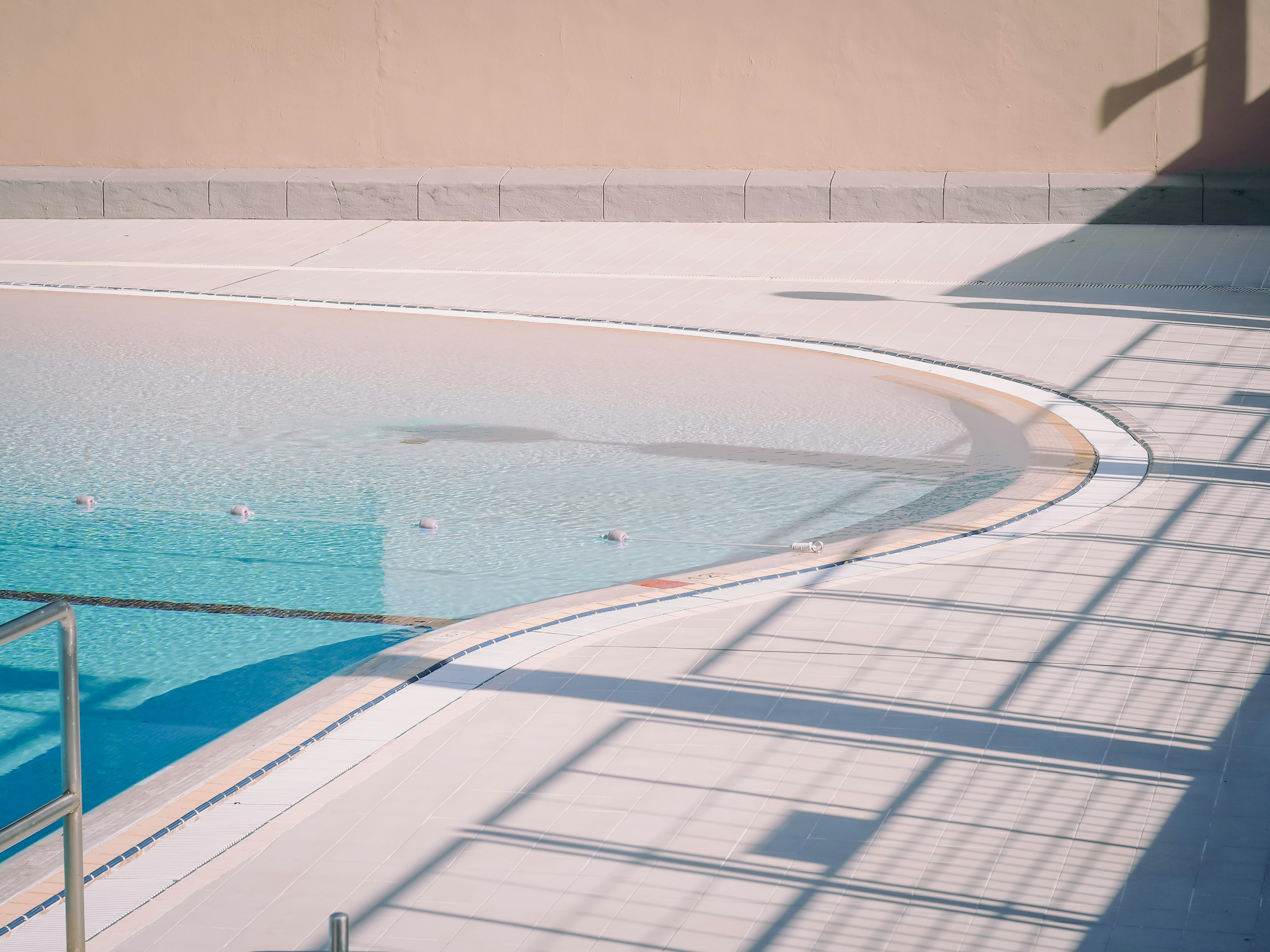 An empty swimming pool with shadows on the ground photo – Free Human ...