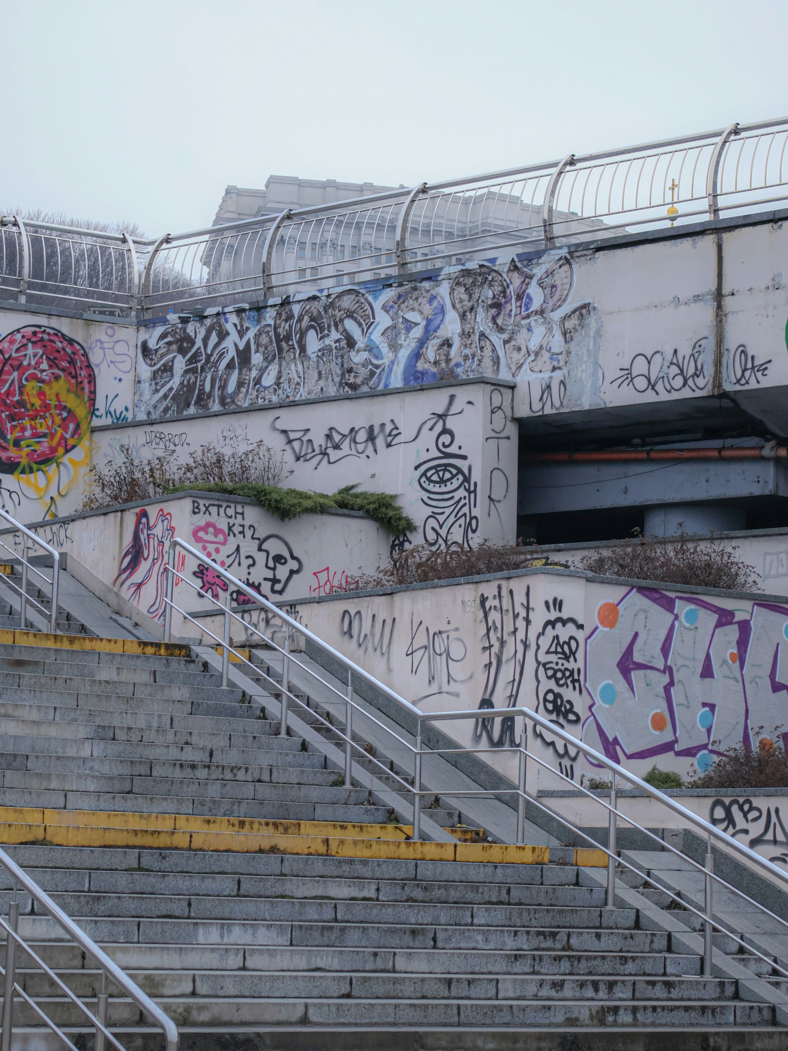 Graffiti Staircase: A Concrete Canvas Under a Graffitied Overpass