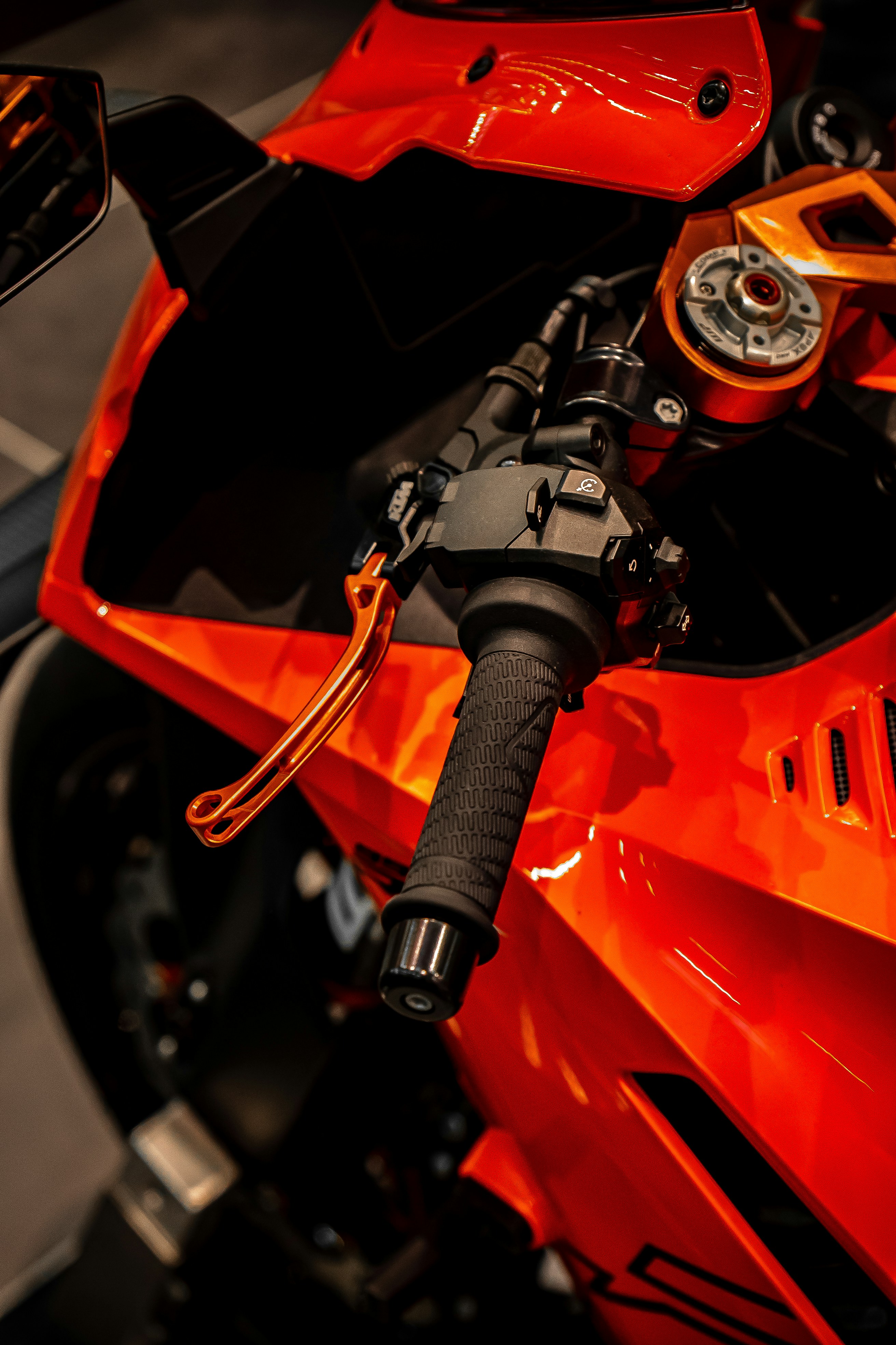 Fiery Red Moto Cockpit: Close-Up on Grip, Lever, and Dial