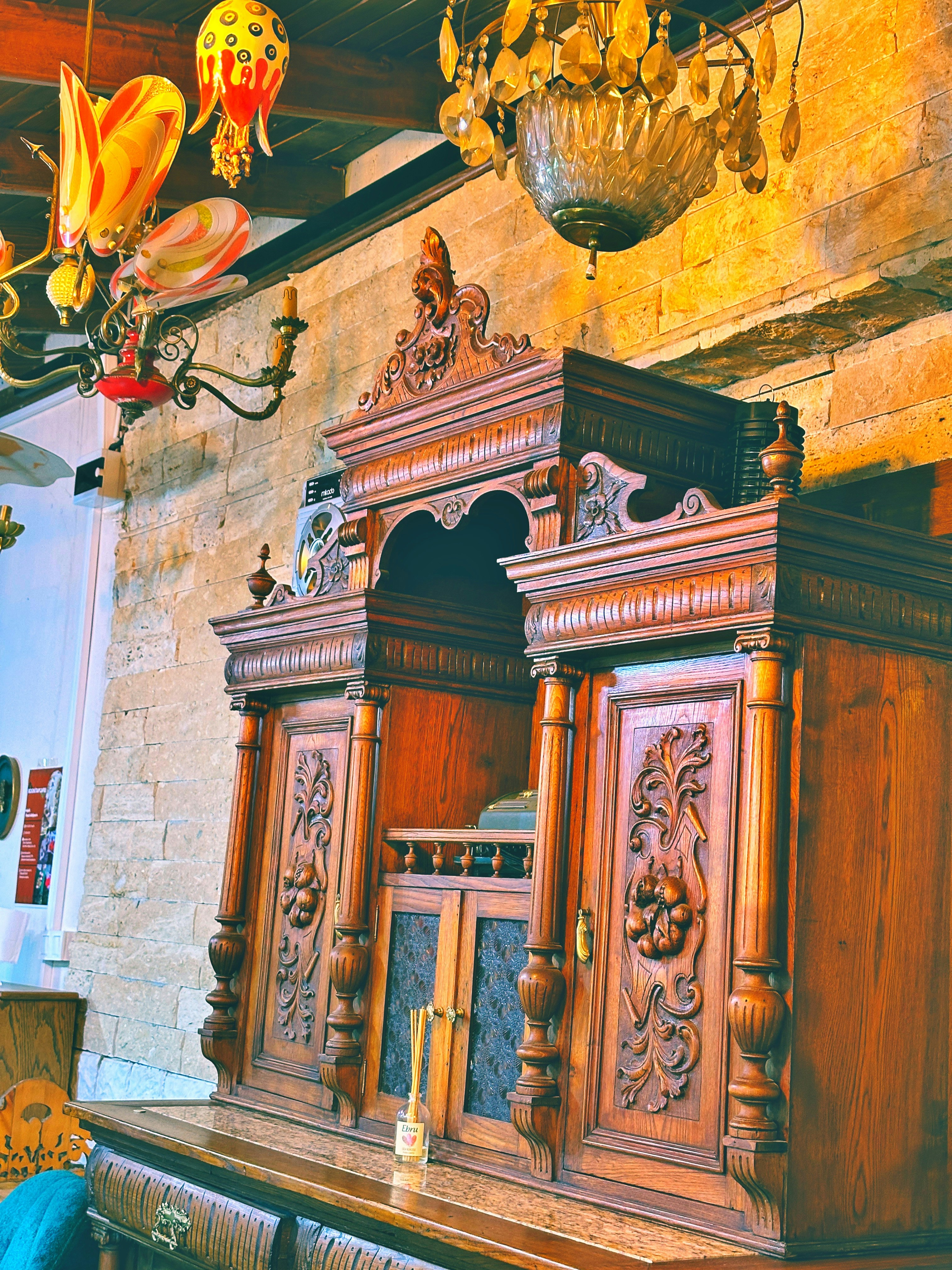 Carved Timekeepers: An Antique Cabinet Under Lantern Light