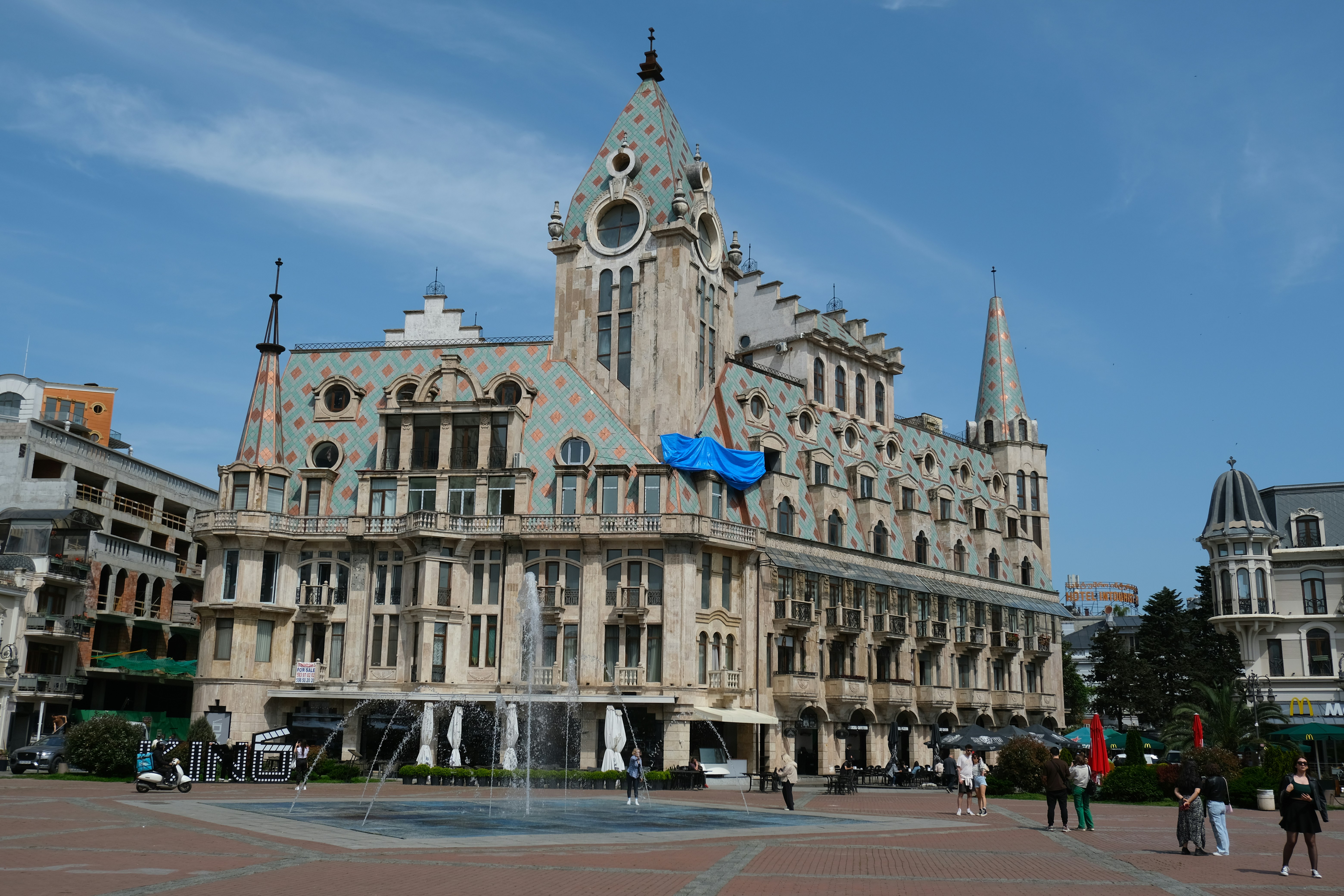 Diamond Facade in Barcelona: Spires Rise Over a Sunlit Plaza