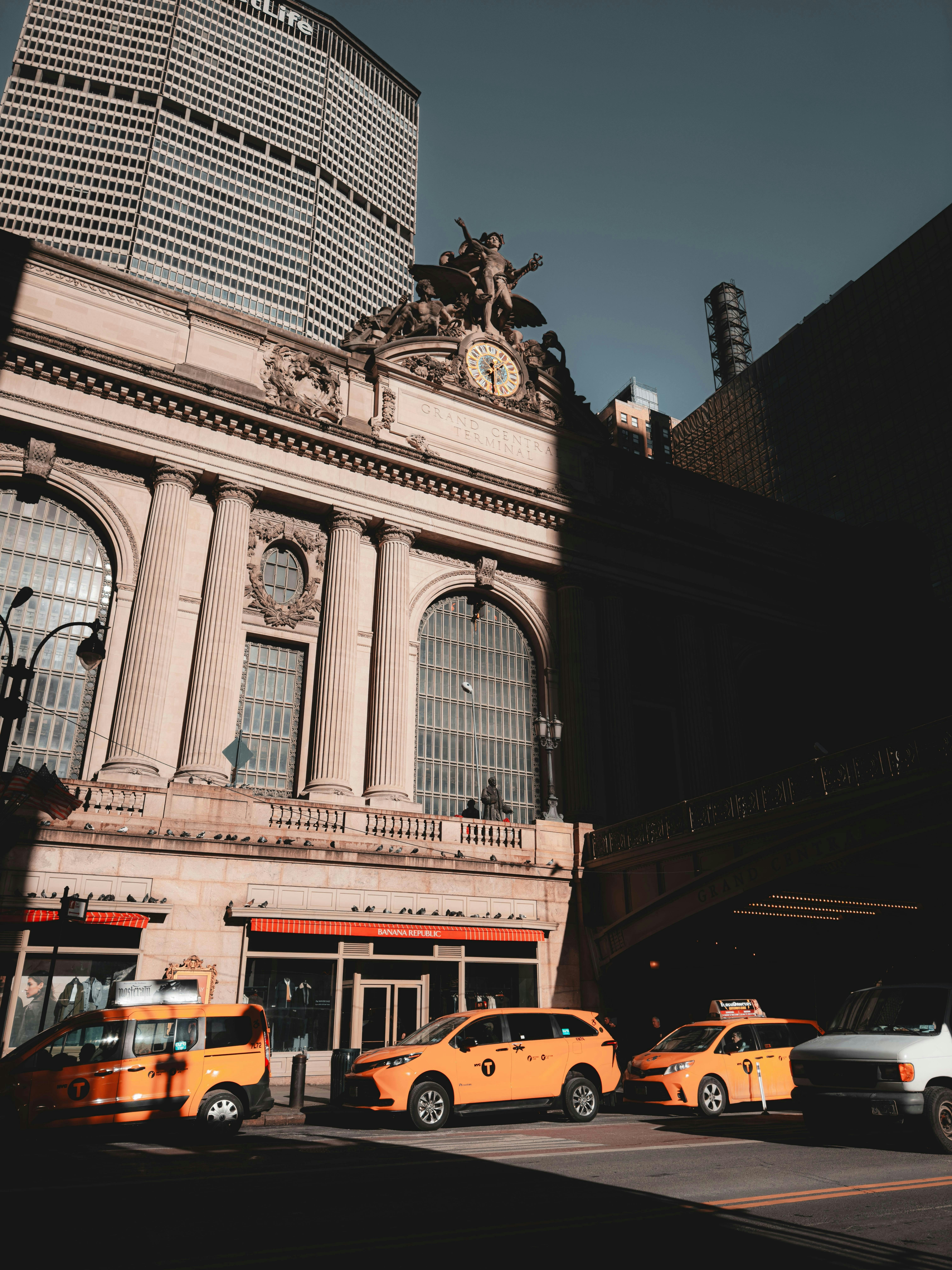 Taxi cabs are parked in front of a building photo – Free Building Image ...