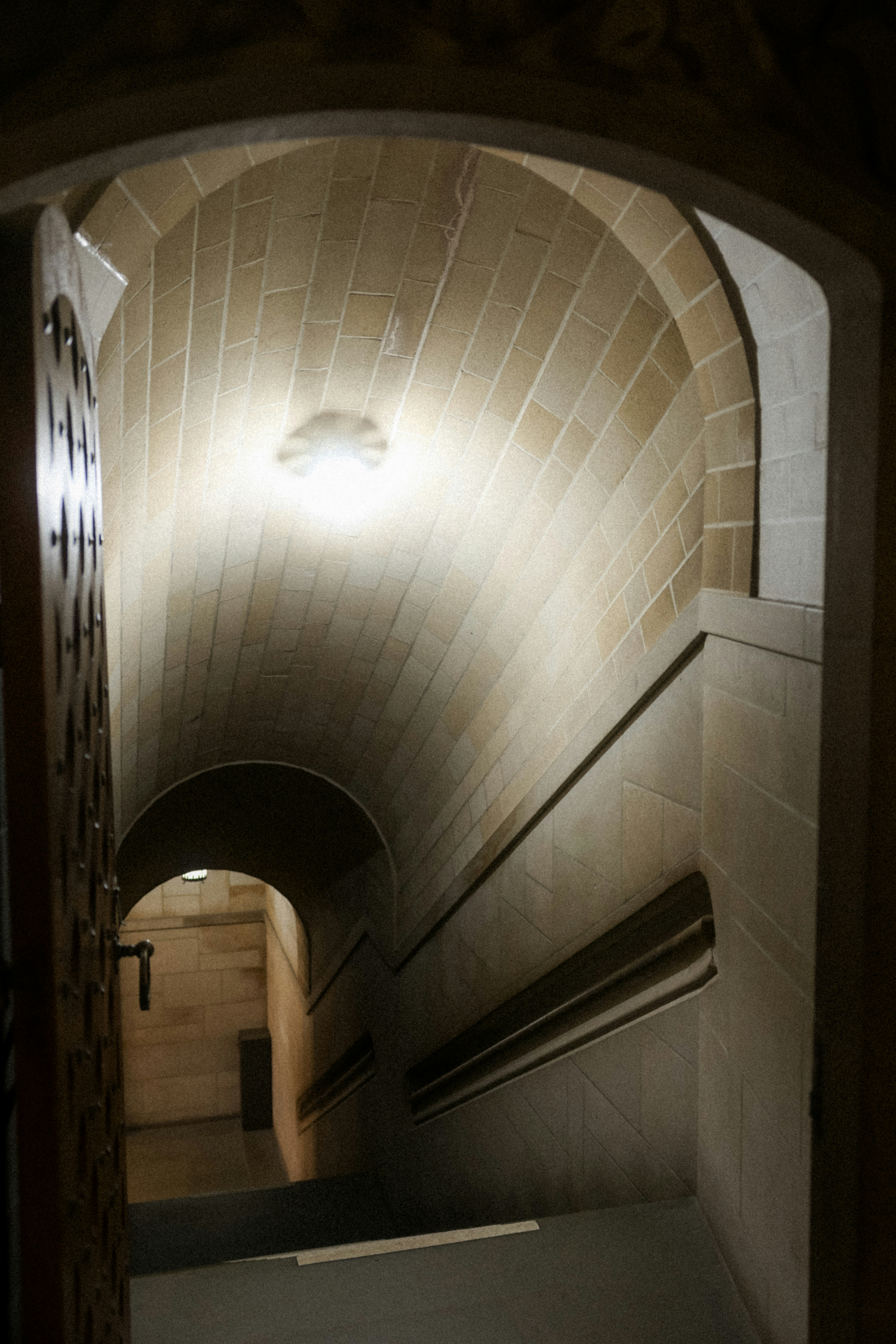 A view of a hallway from the bottom of the stairs