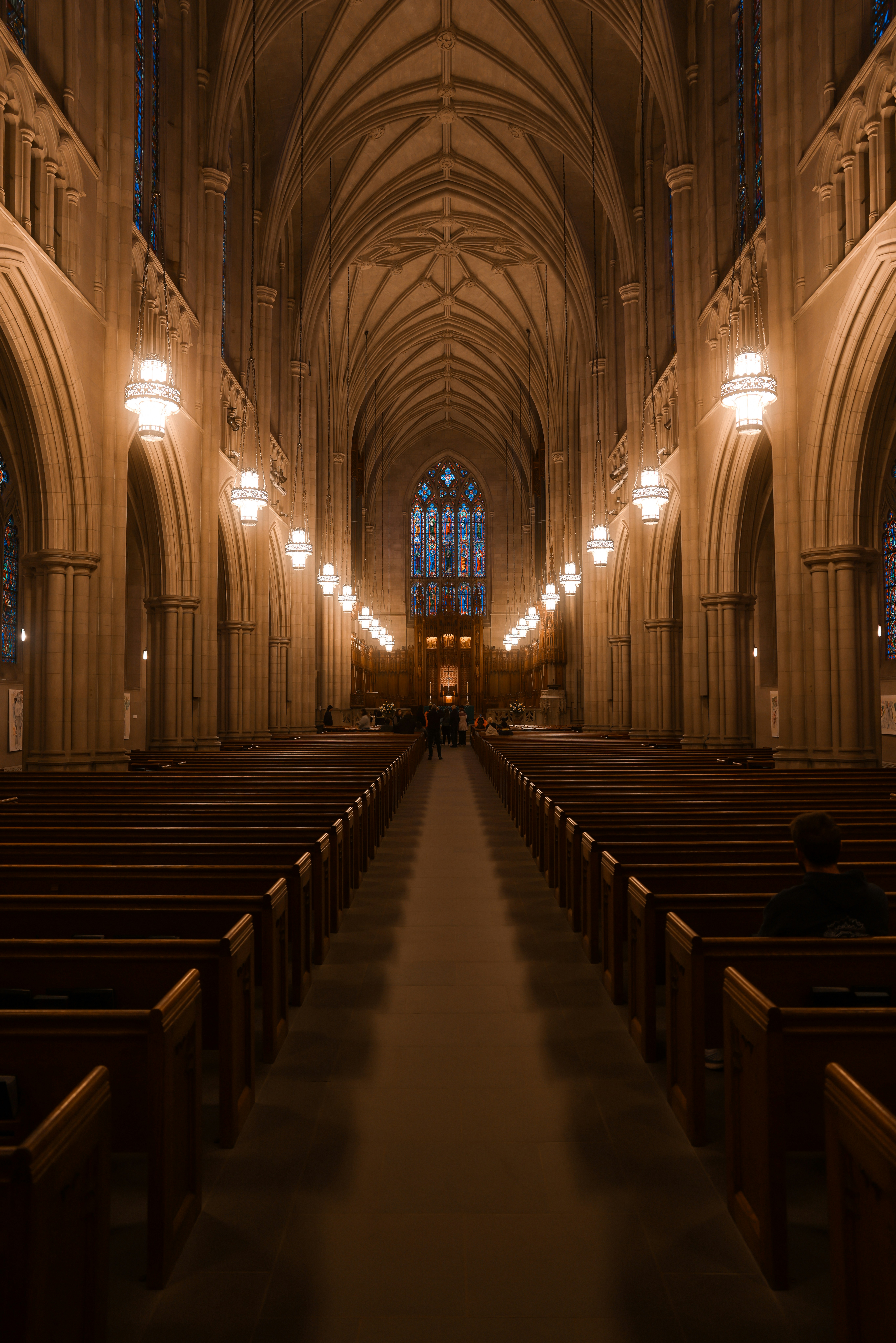 A large cathedral with rows of pews and lights photo – Free Building ...