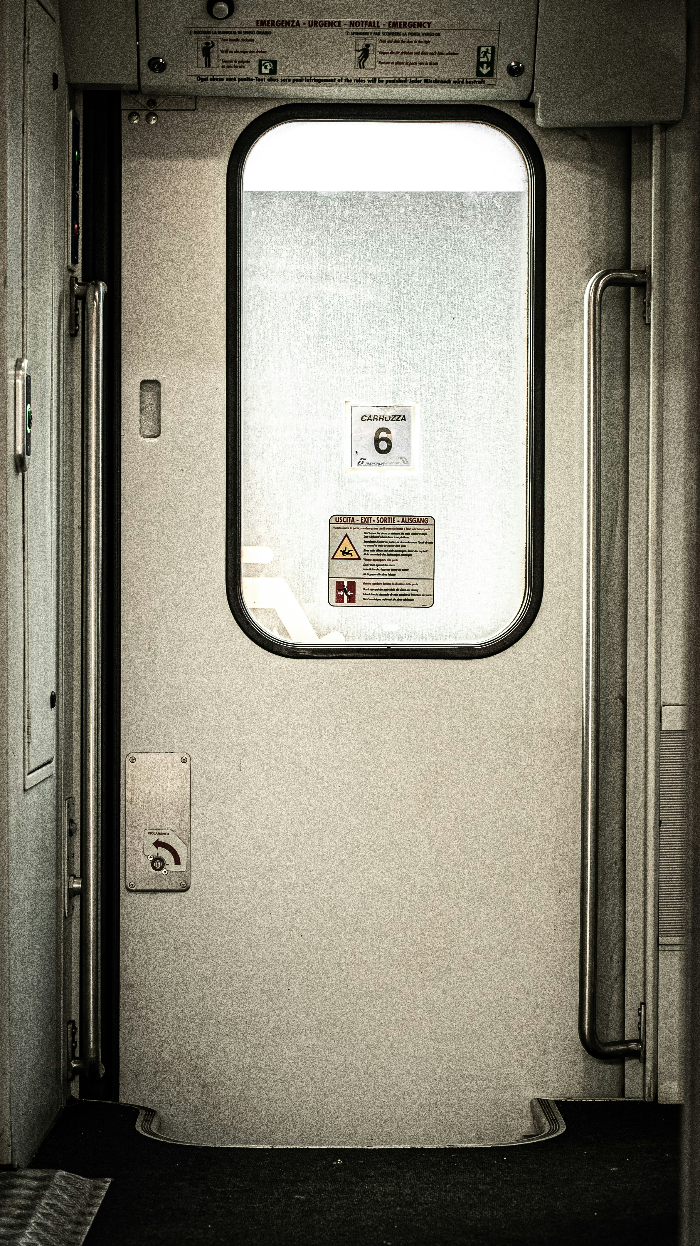 Sepia Threshold: The Subway Door Window in Quiet Light