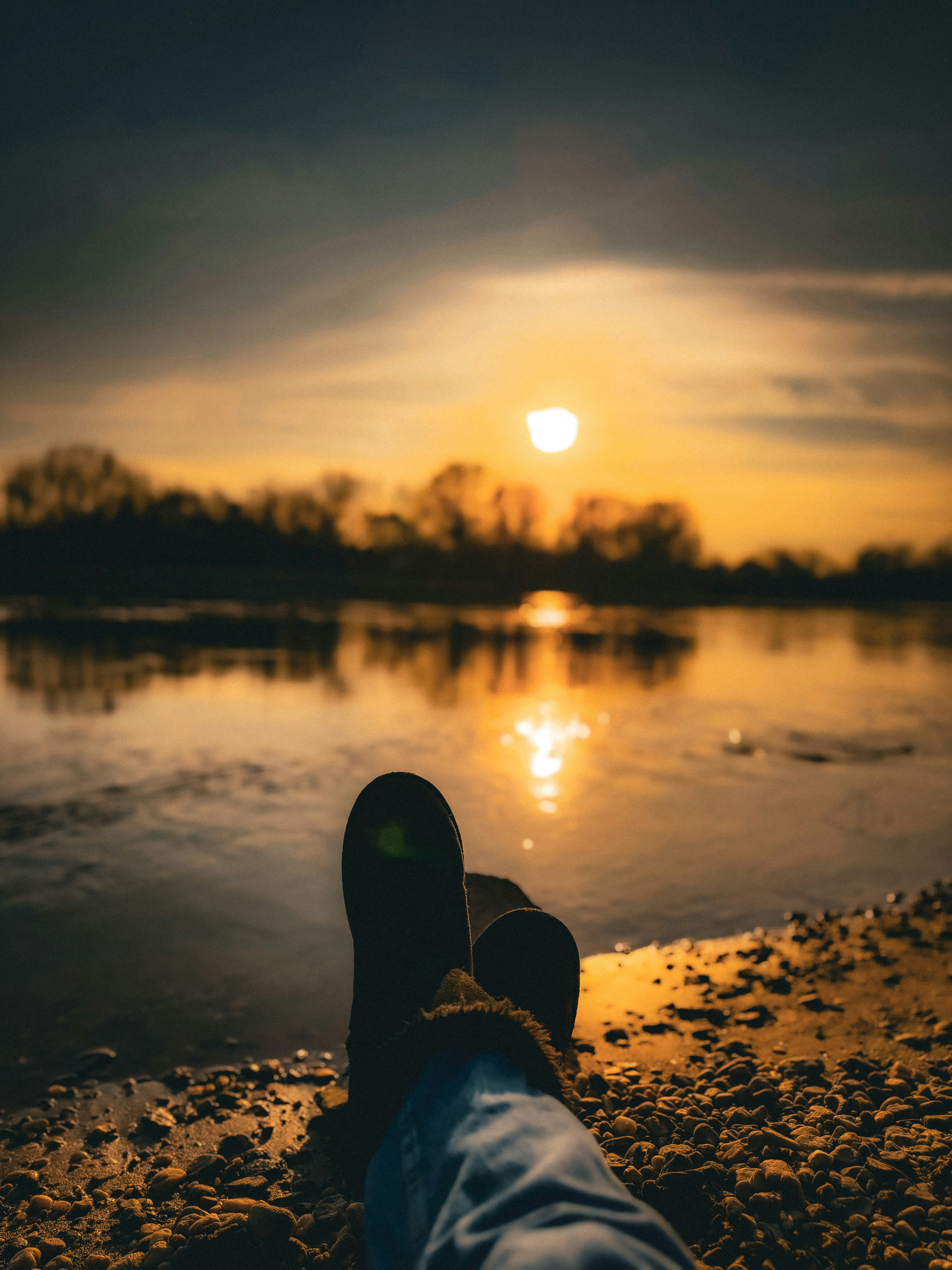 Boots at Dusk: Quiet Contemplation by a Golden River