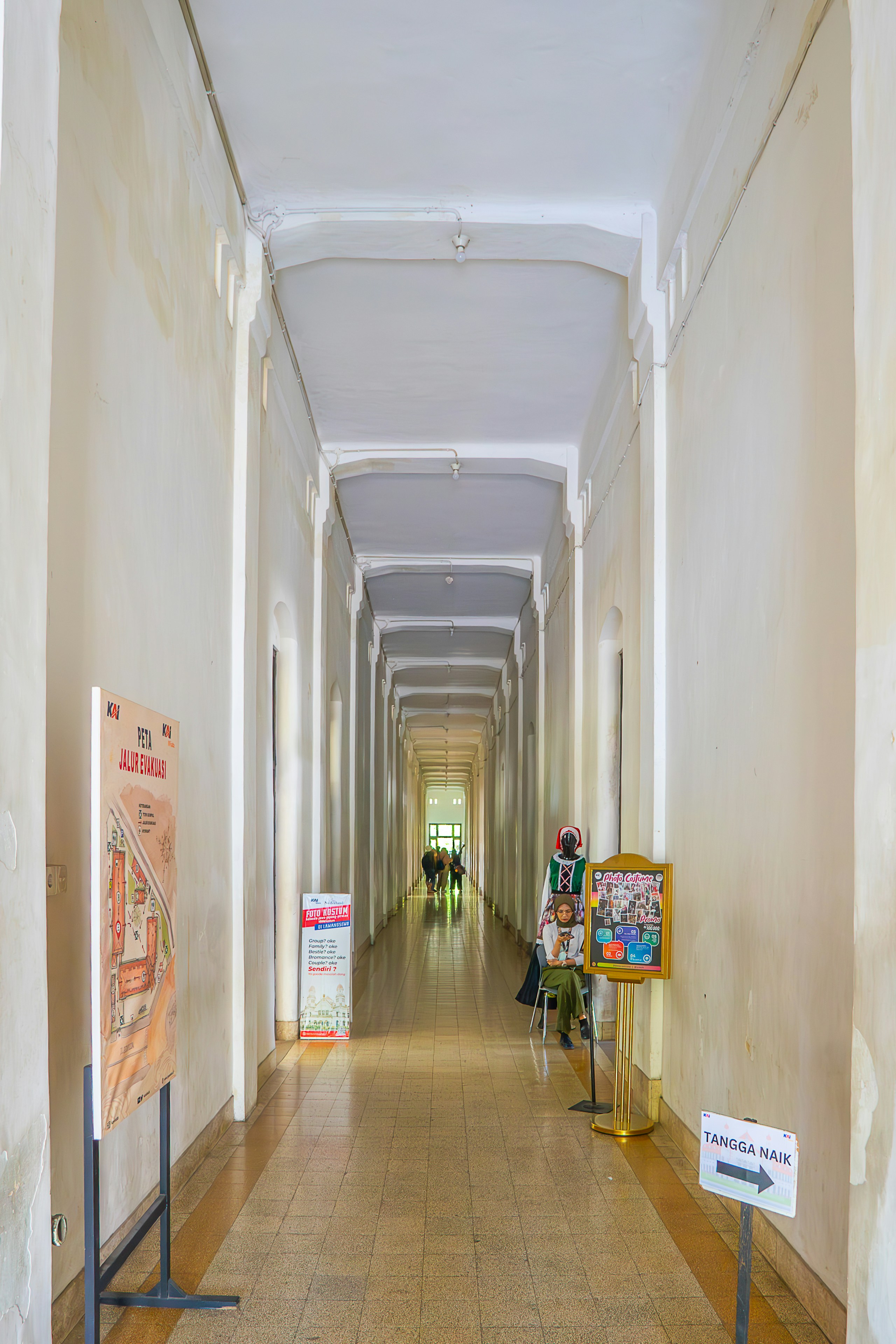 A long hallway with posters and signs on the walls photo – Free Lawang ...