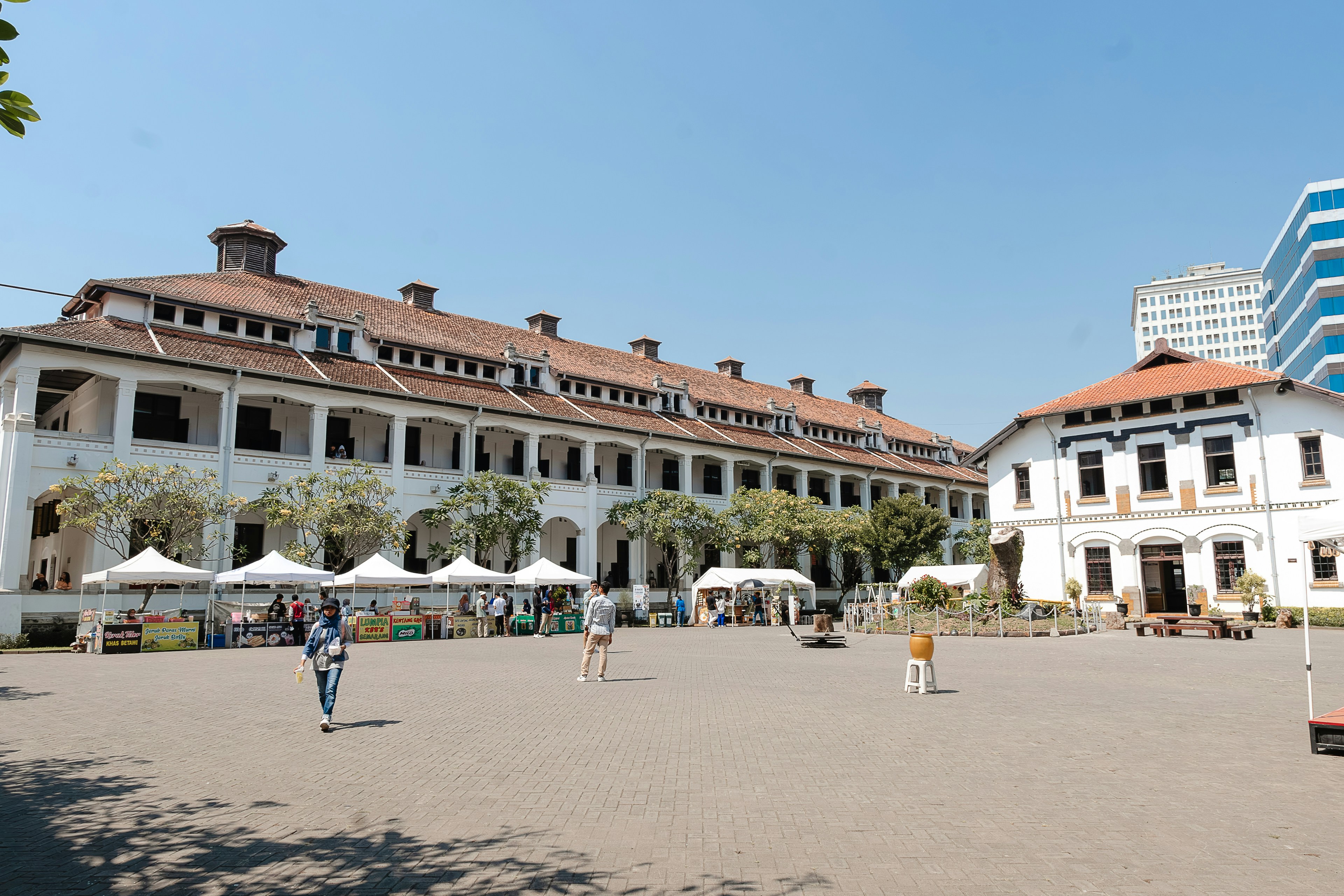 Historic Lawang Sewu building with colonial architecture under a clear blue sky.