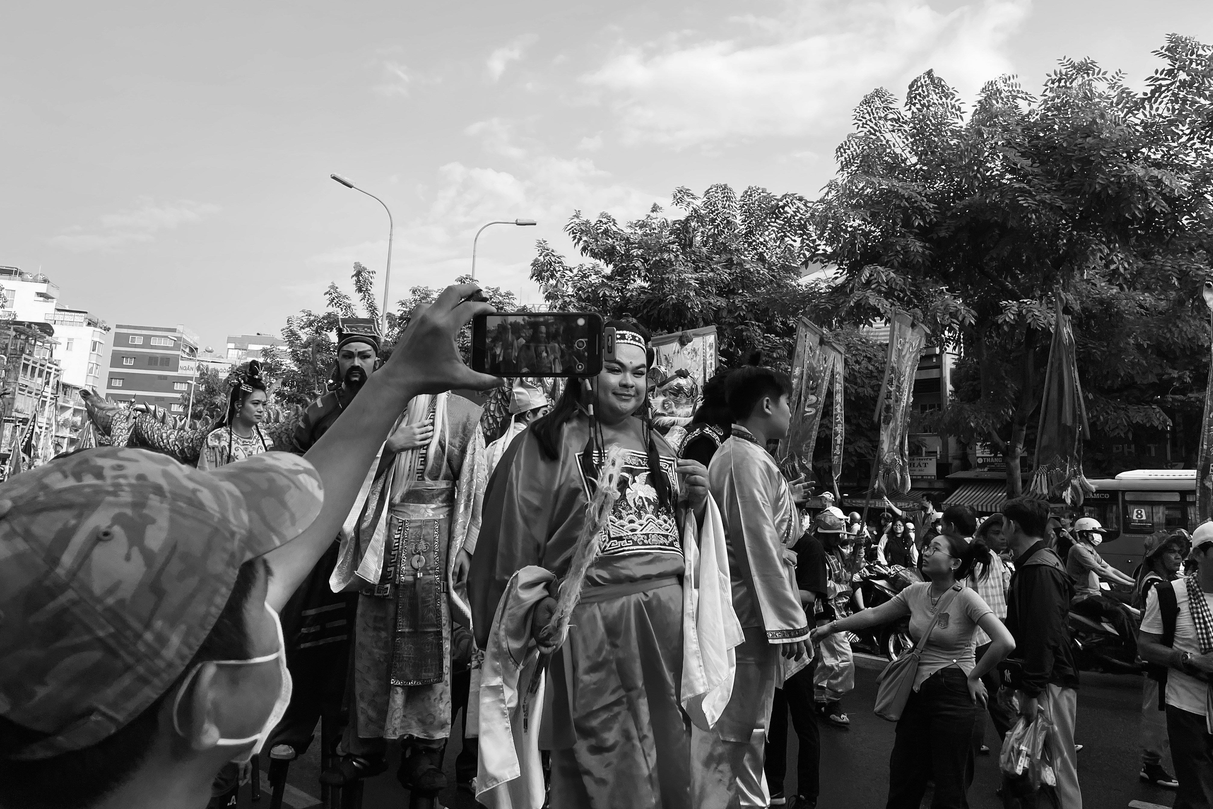 Festival performers in traditional attire captured during a lively street parade.
