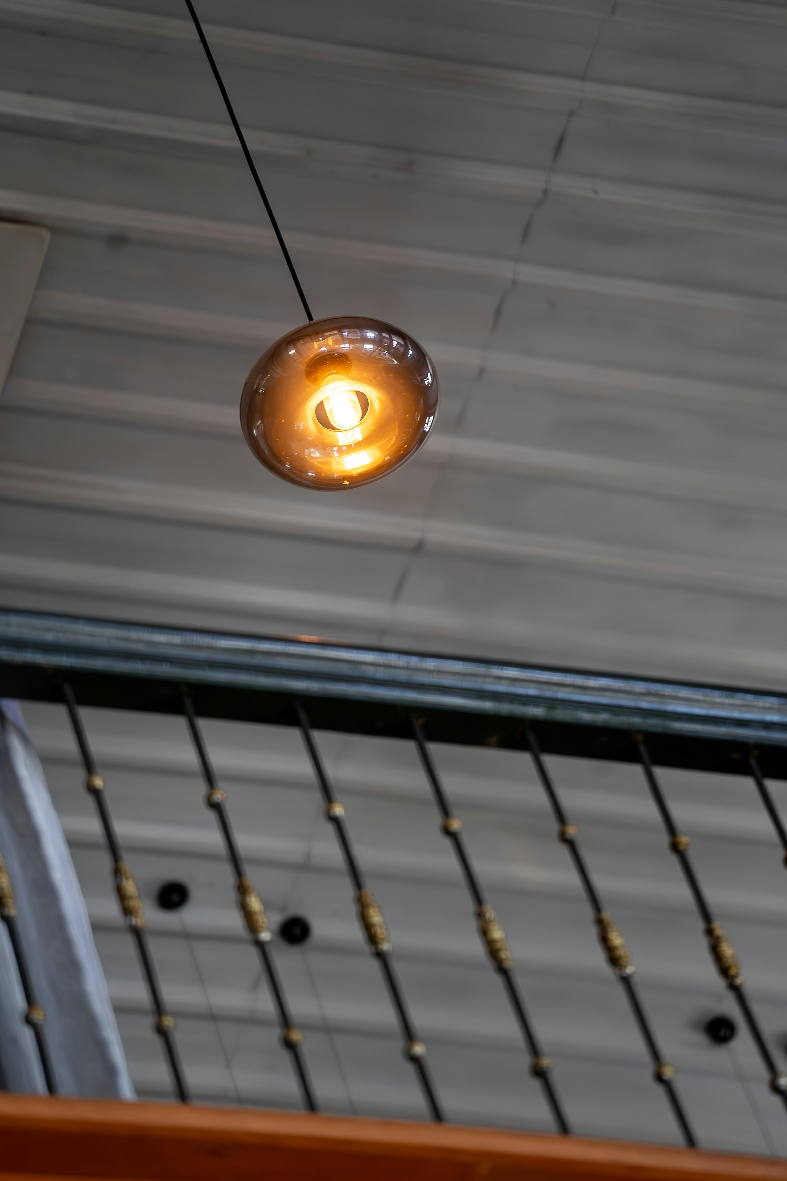 Amber Orb Pendant Light Anchored in an Industrial Loft