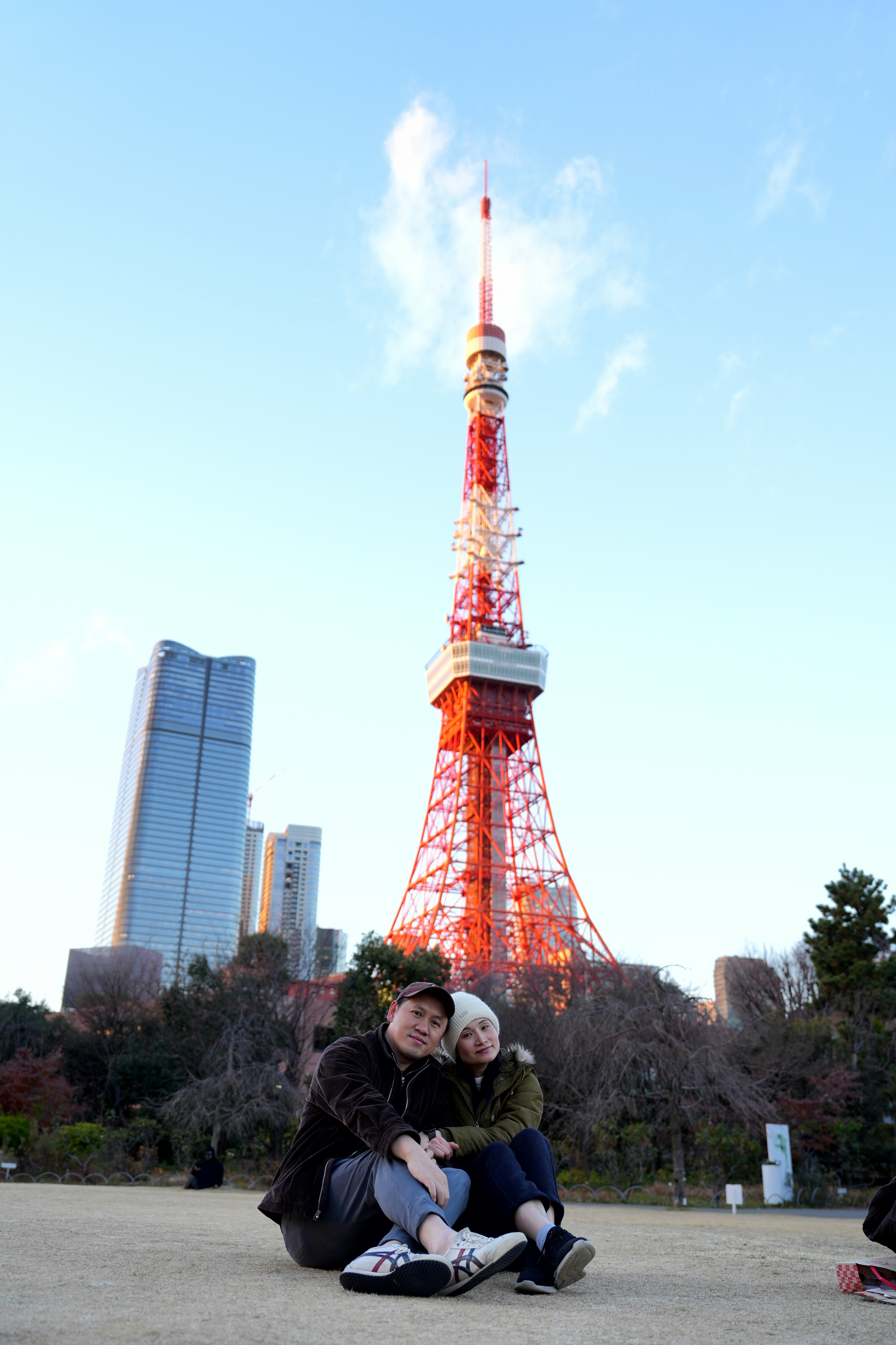 Lovers at Tokyo Tower: a Moment Beneath a Red Lattice Skyscraper