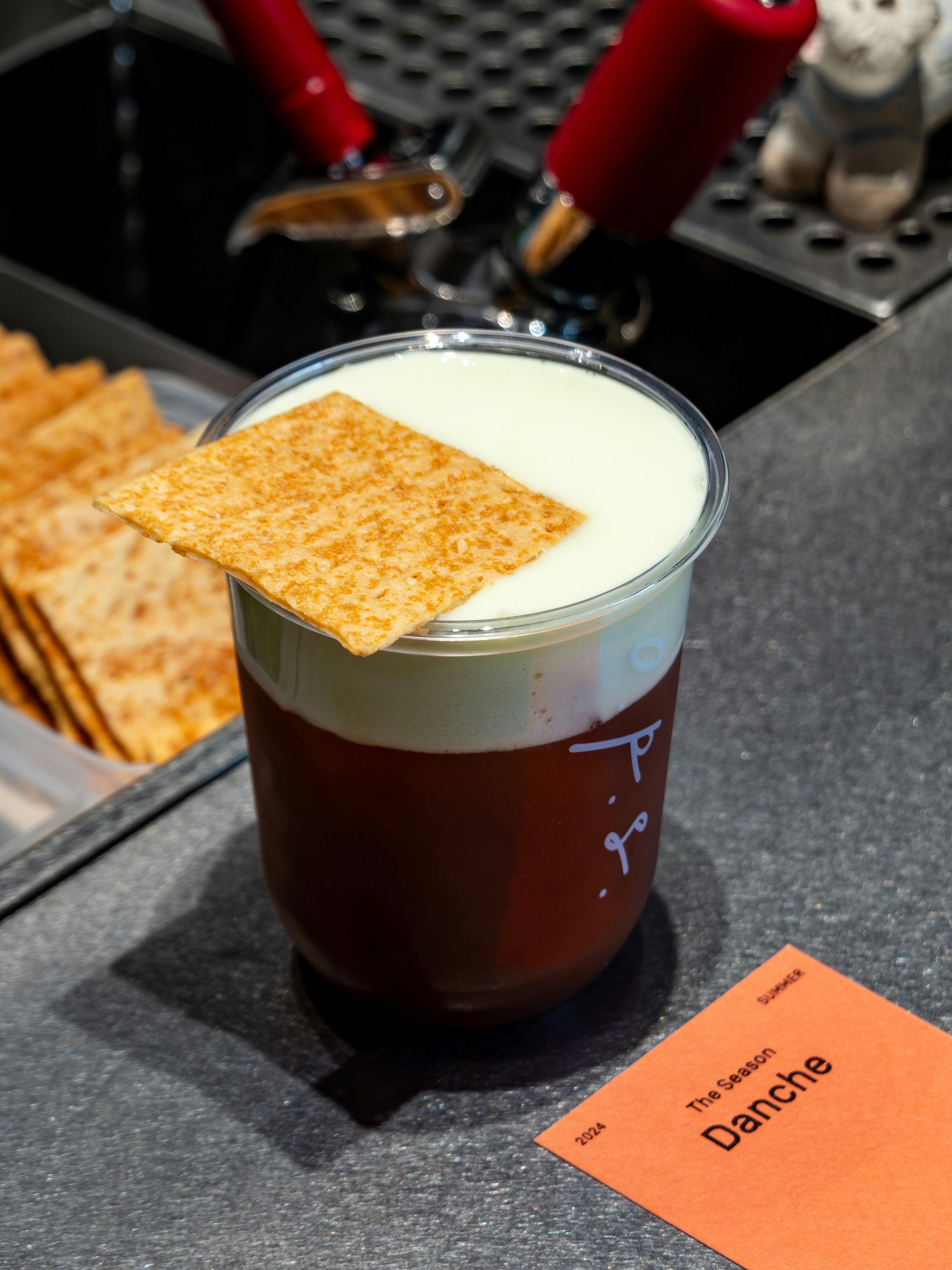 A cup of drink and crackers on a counter photo – Free Coffee Image on ...