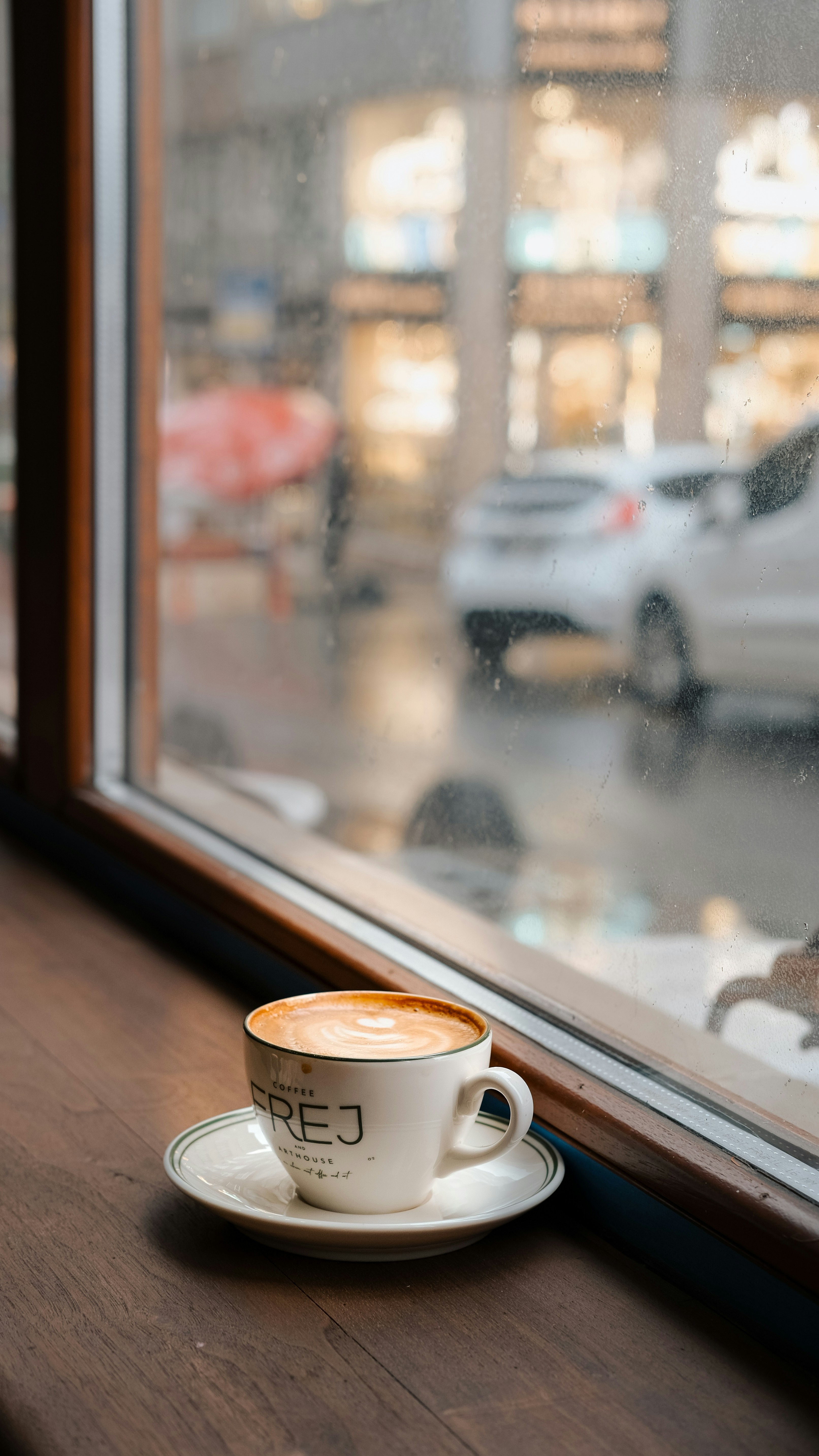 A cup of coffee sitting on a window sill photo – Free Coffee Image on ...