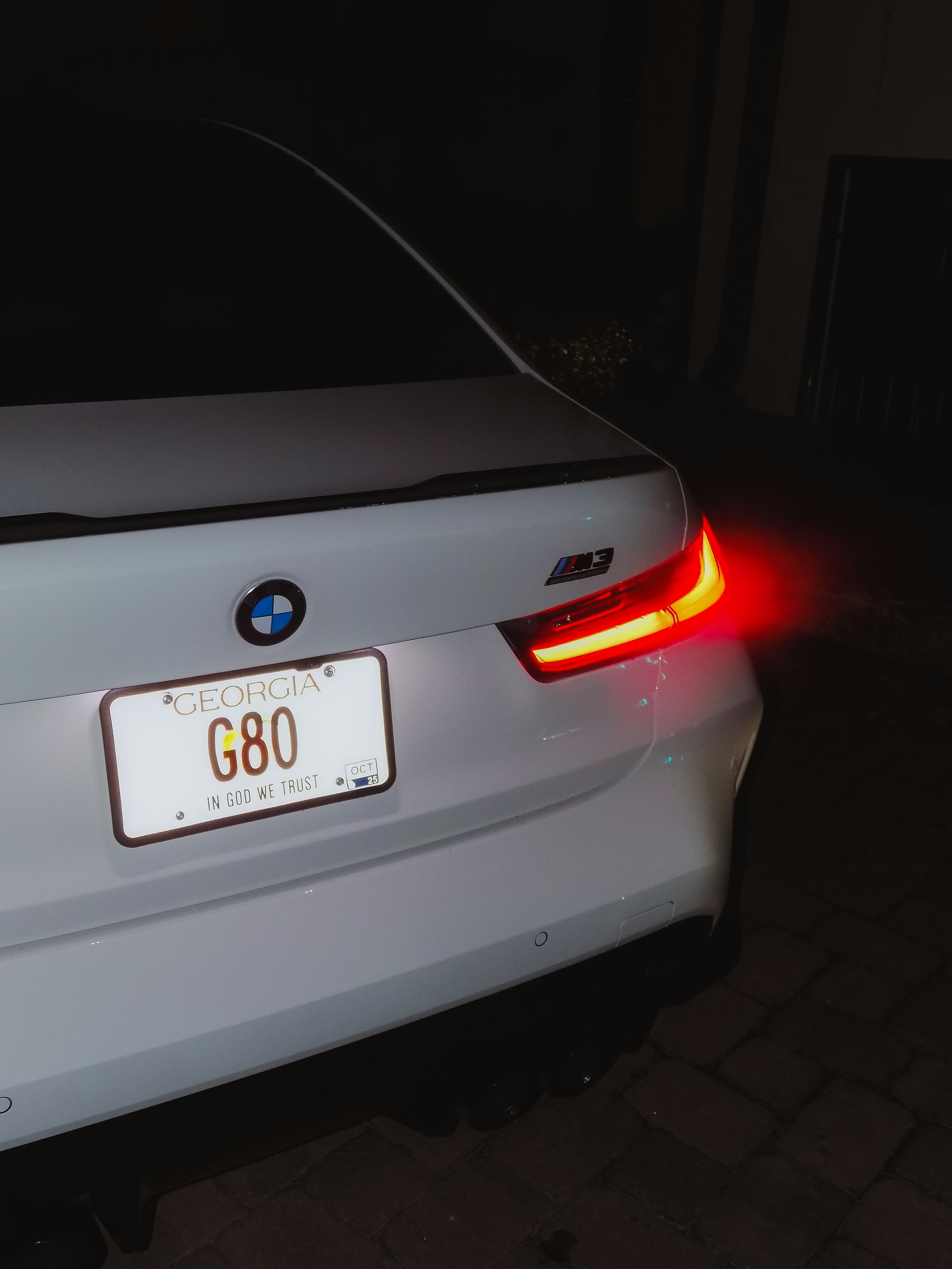 Crimson Taillight, Georgia Plate: Night Rear of a White BMW M3