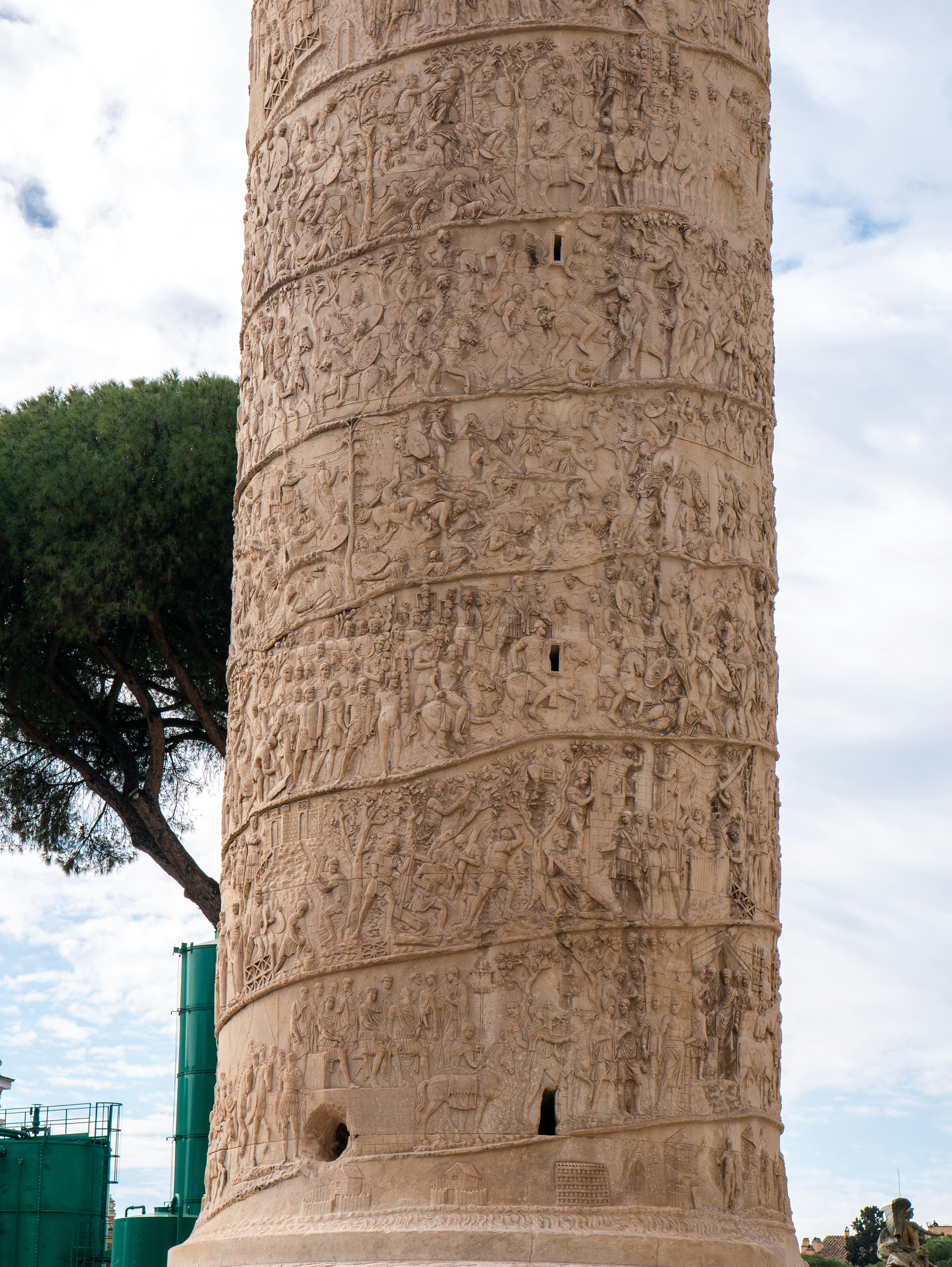 A tall stone pillar with a tree in the background photo – Free Ruins ...