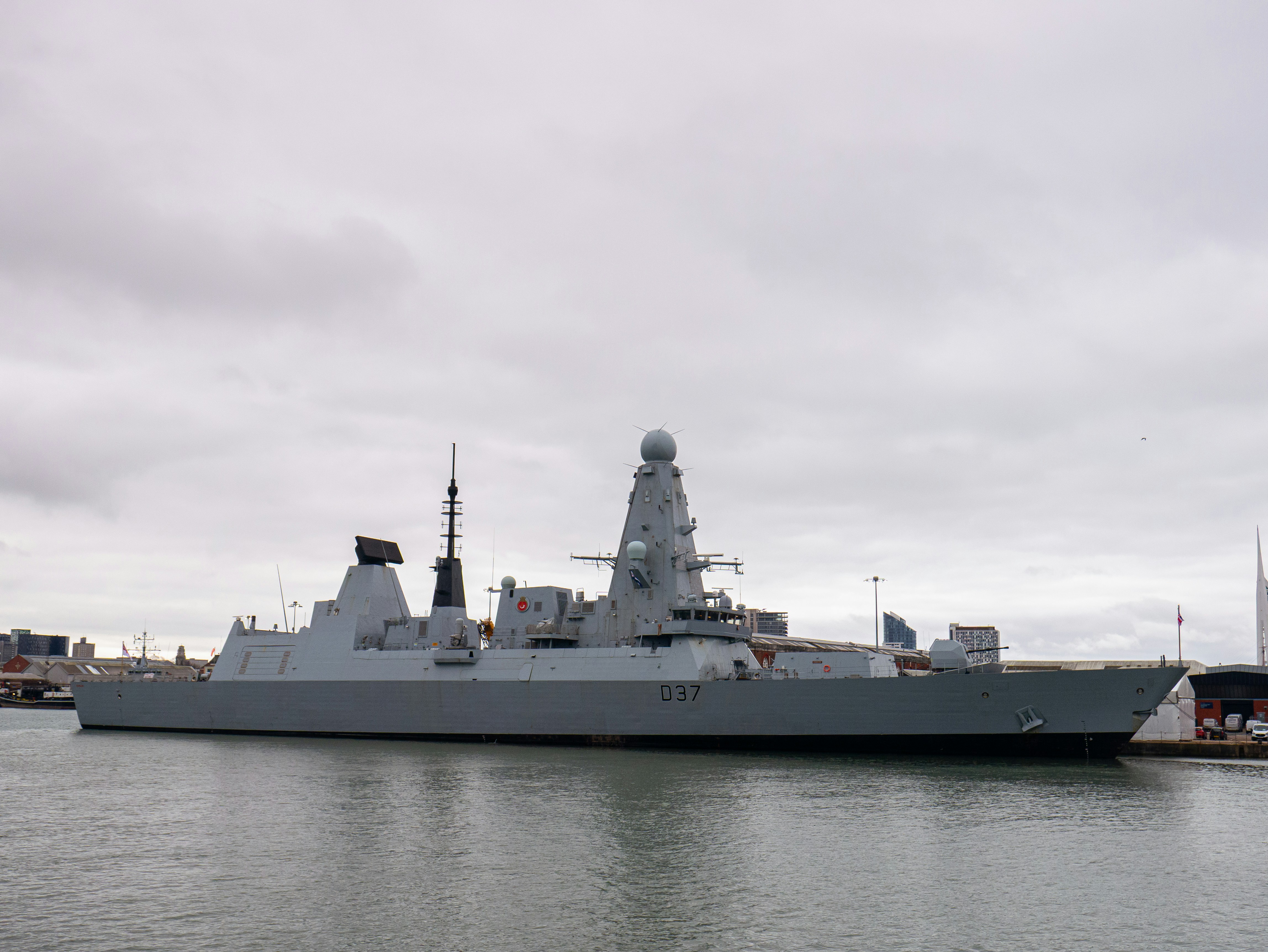 A large battleship sitting in the middle of a body of water photo ...