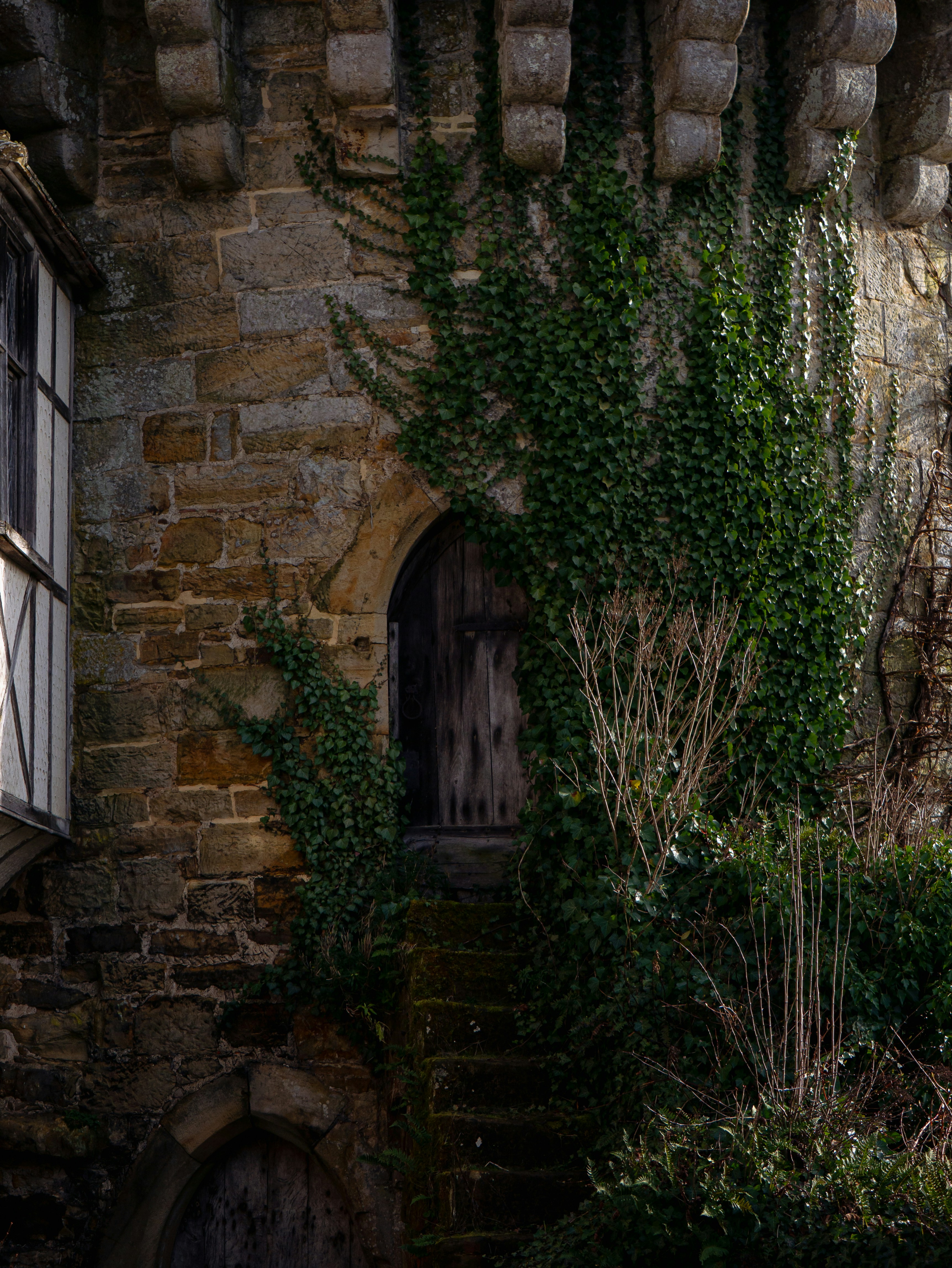 A stone building with a clock on the side of it photo – Free ...