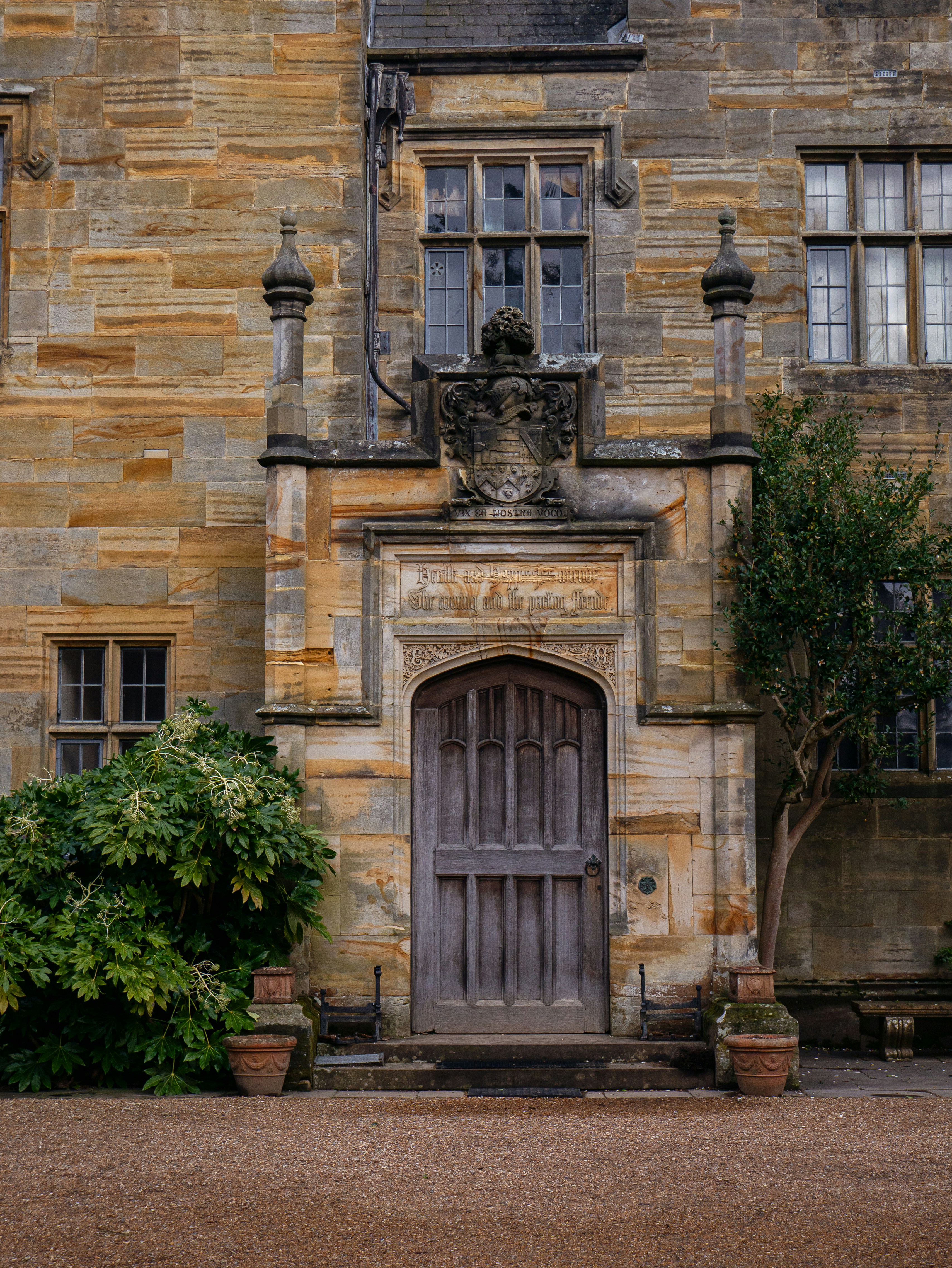 Heritage Doorway: Carved Stone Portal on a Weathered Manor