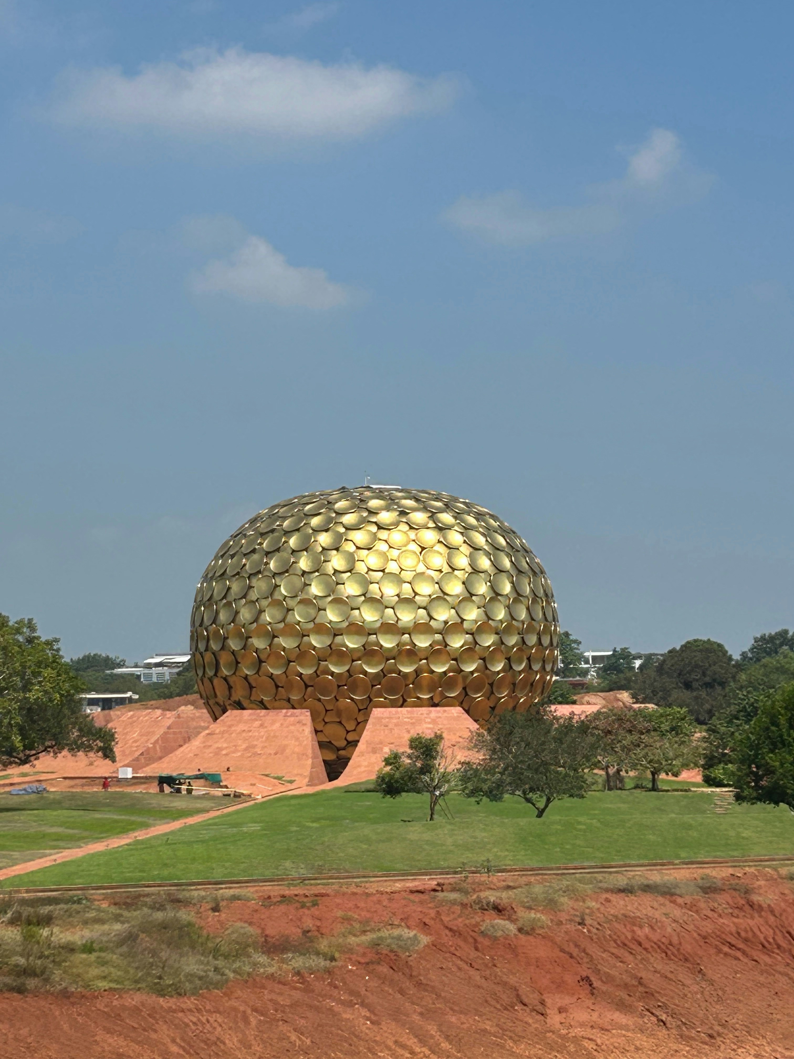 Sunlit Gilded Orb atop Red Terraces