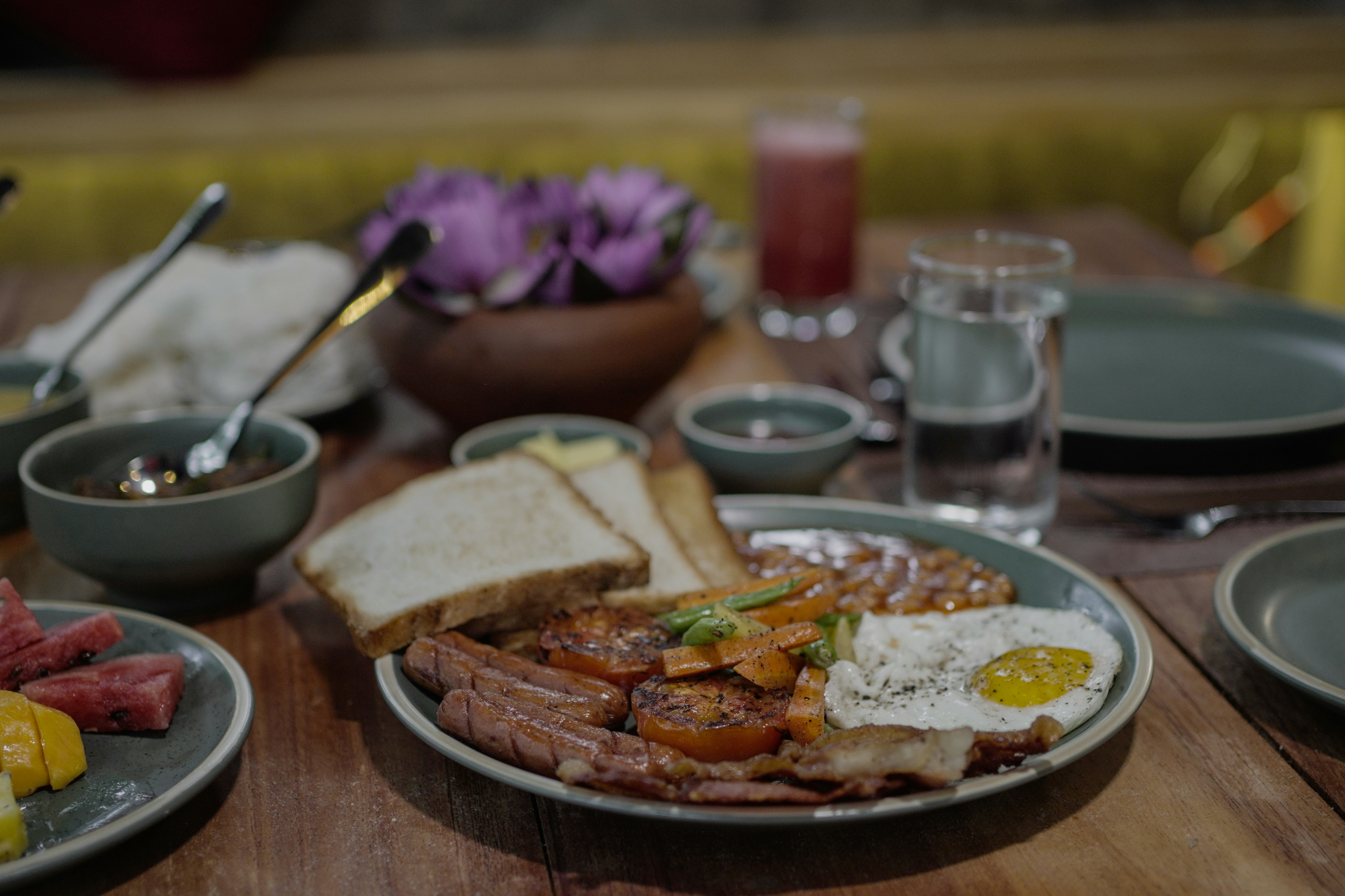 Morning Brunch on a Wooden Table: Sausage Hash, Toast and Sunny Eggs