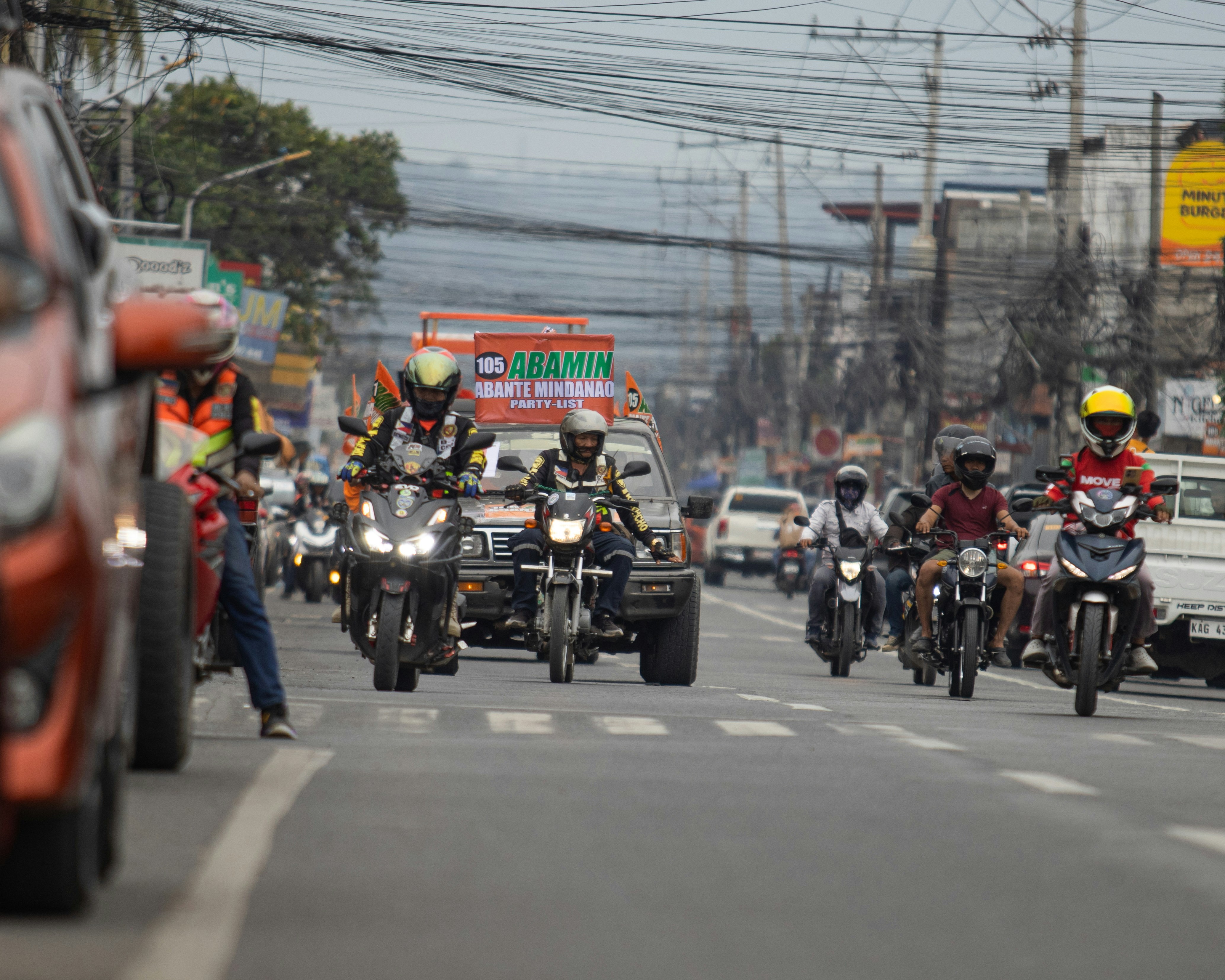 A group of people riding motorcycles down a street photo – Free Car ...