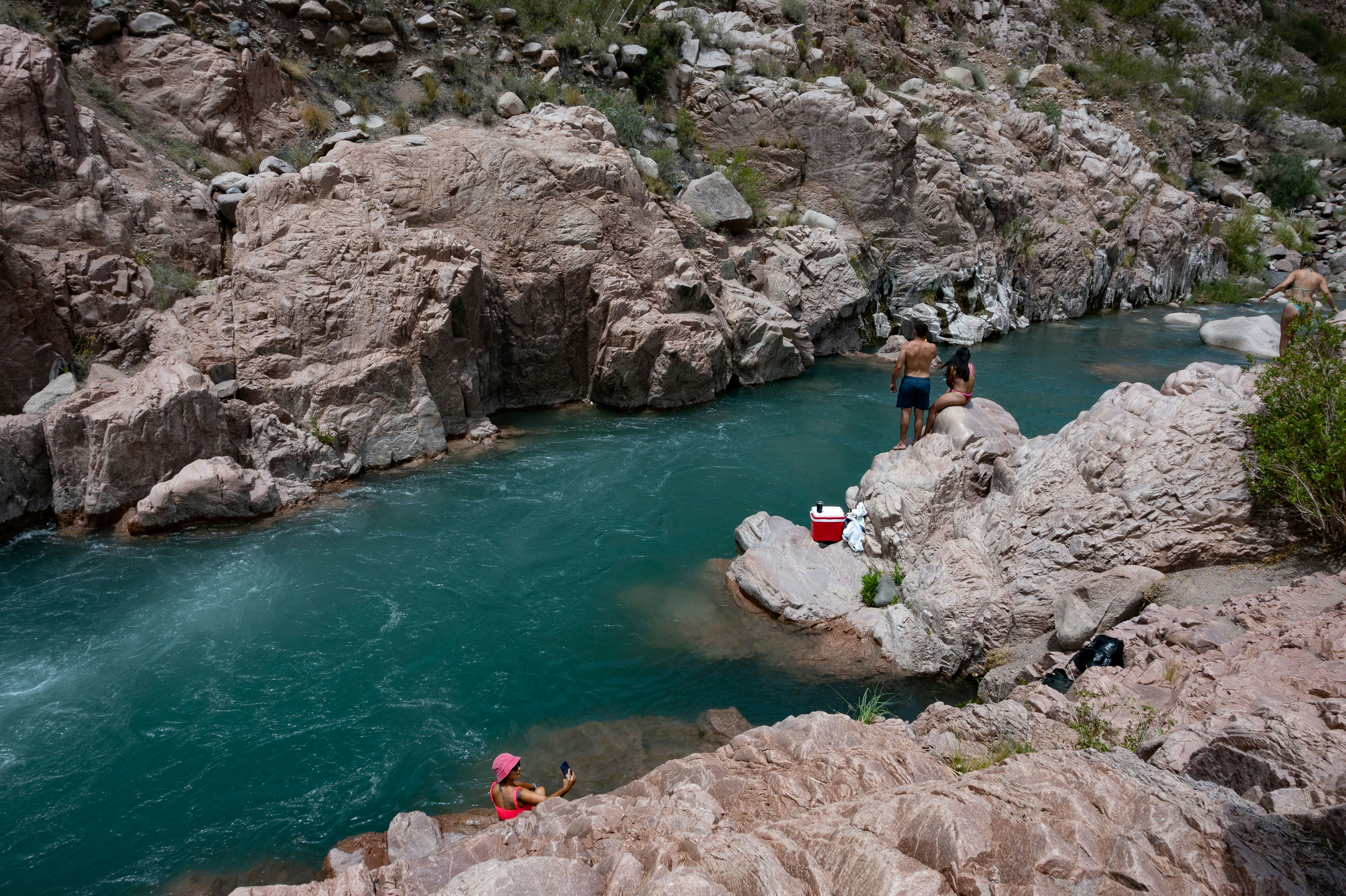 Serene Cliffside Gathering Beside Turquoise Rapids