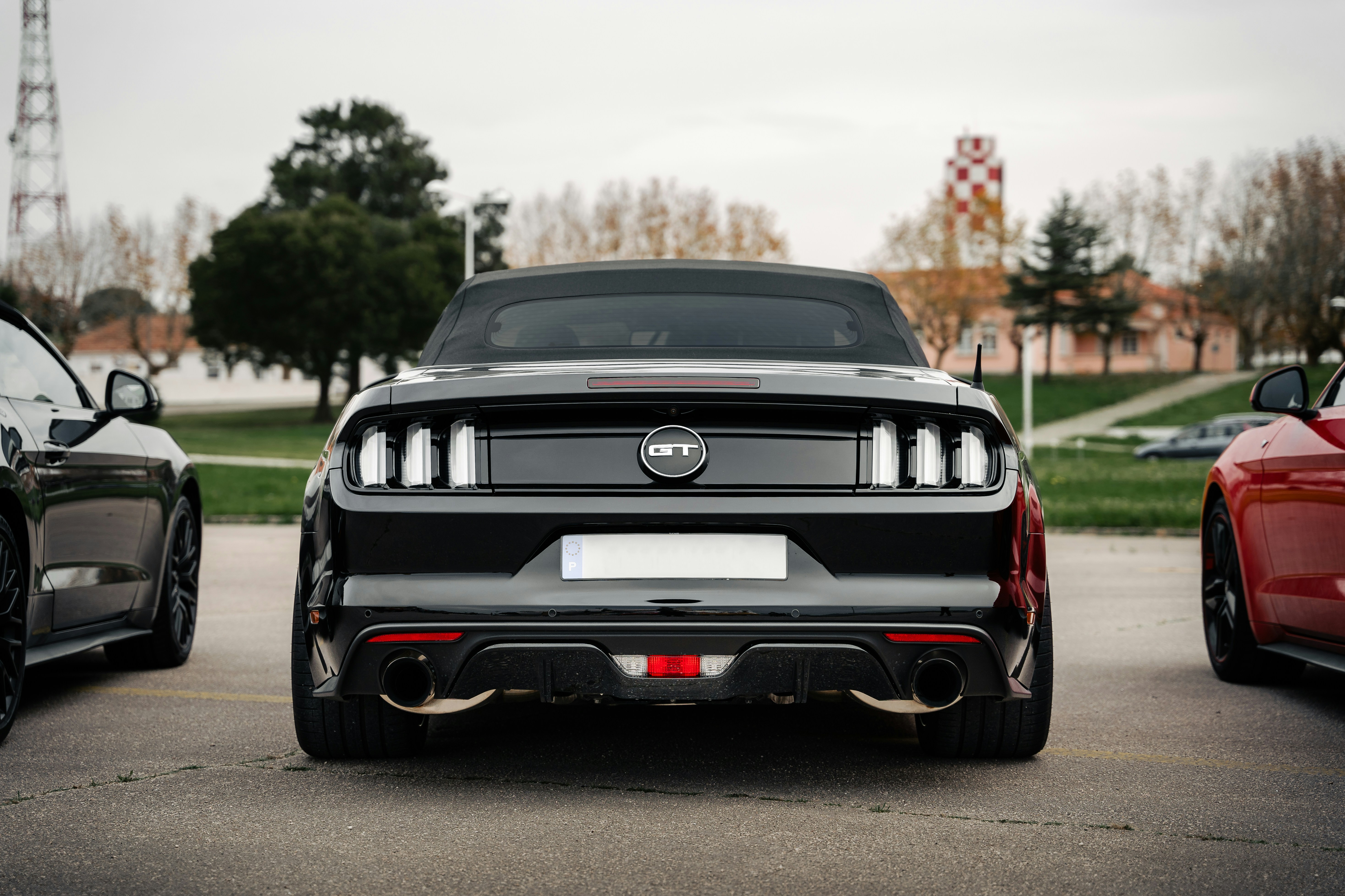 Rear Portrait of a Black Mustang GT in a Quiet Parking Lot
