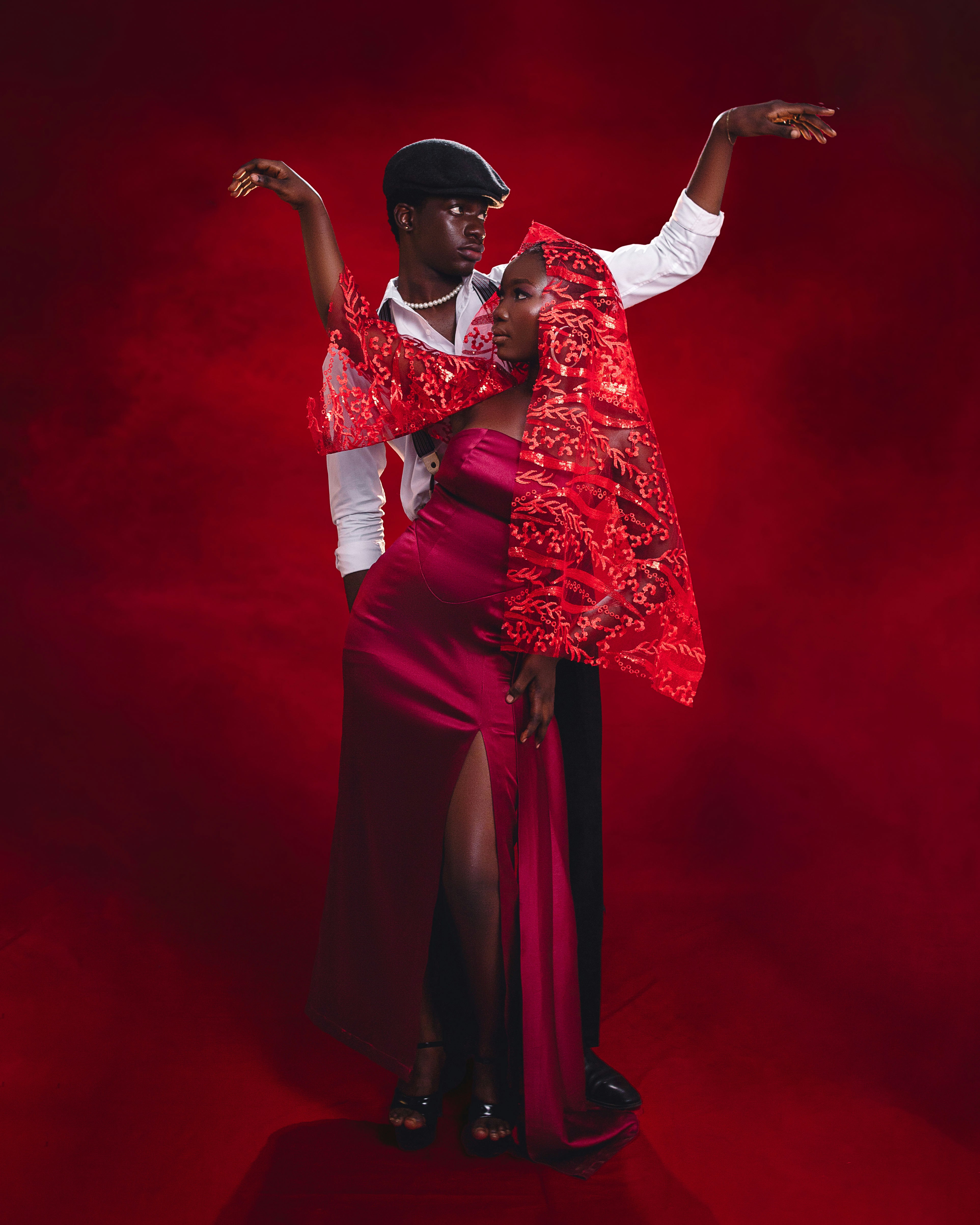 A man and a woman dance together on a red background photo – Free ...