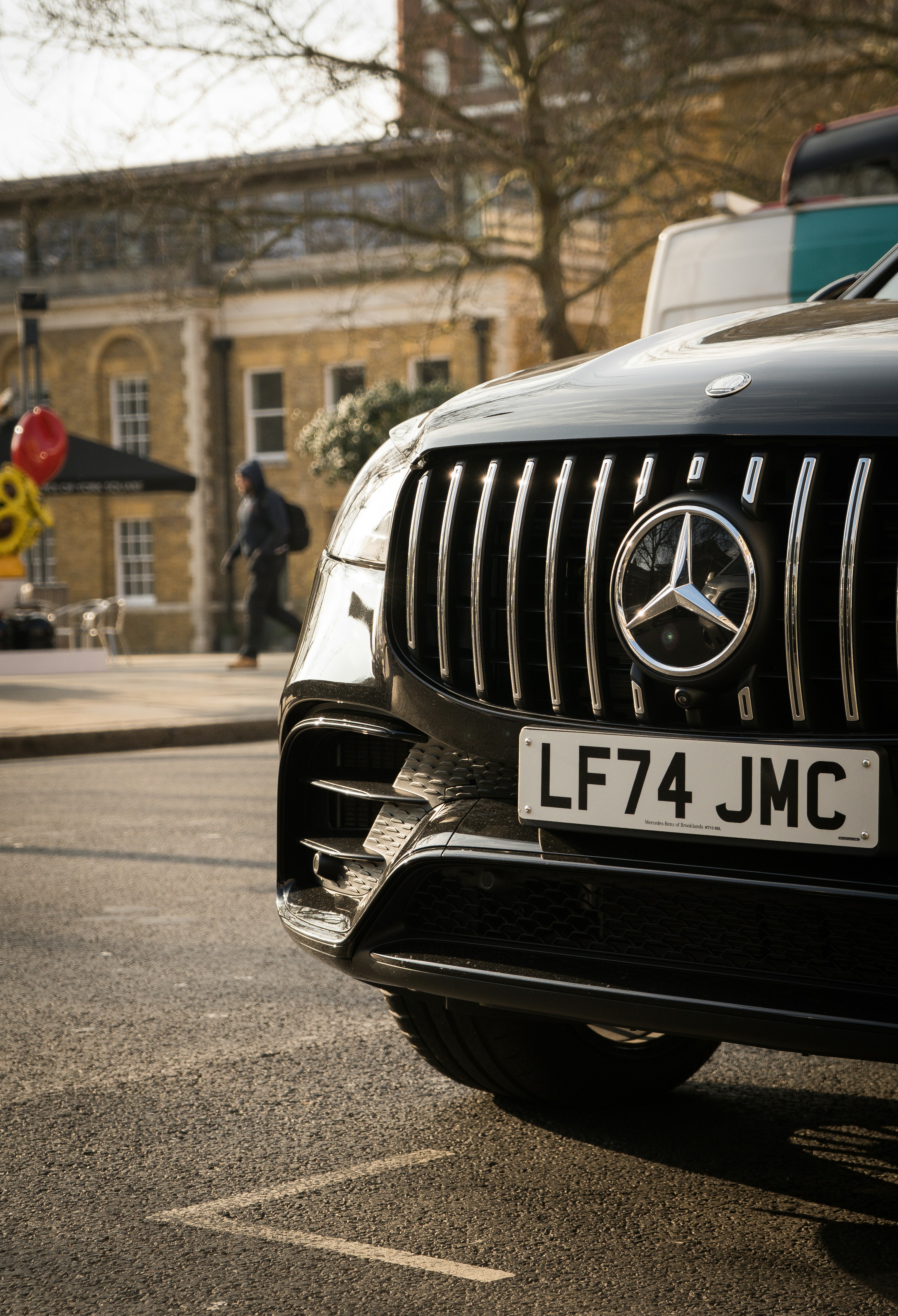 Luminous Grille: A Mercedes-Benz Commands a Sunlit City Street