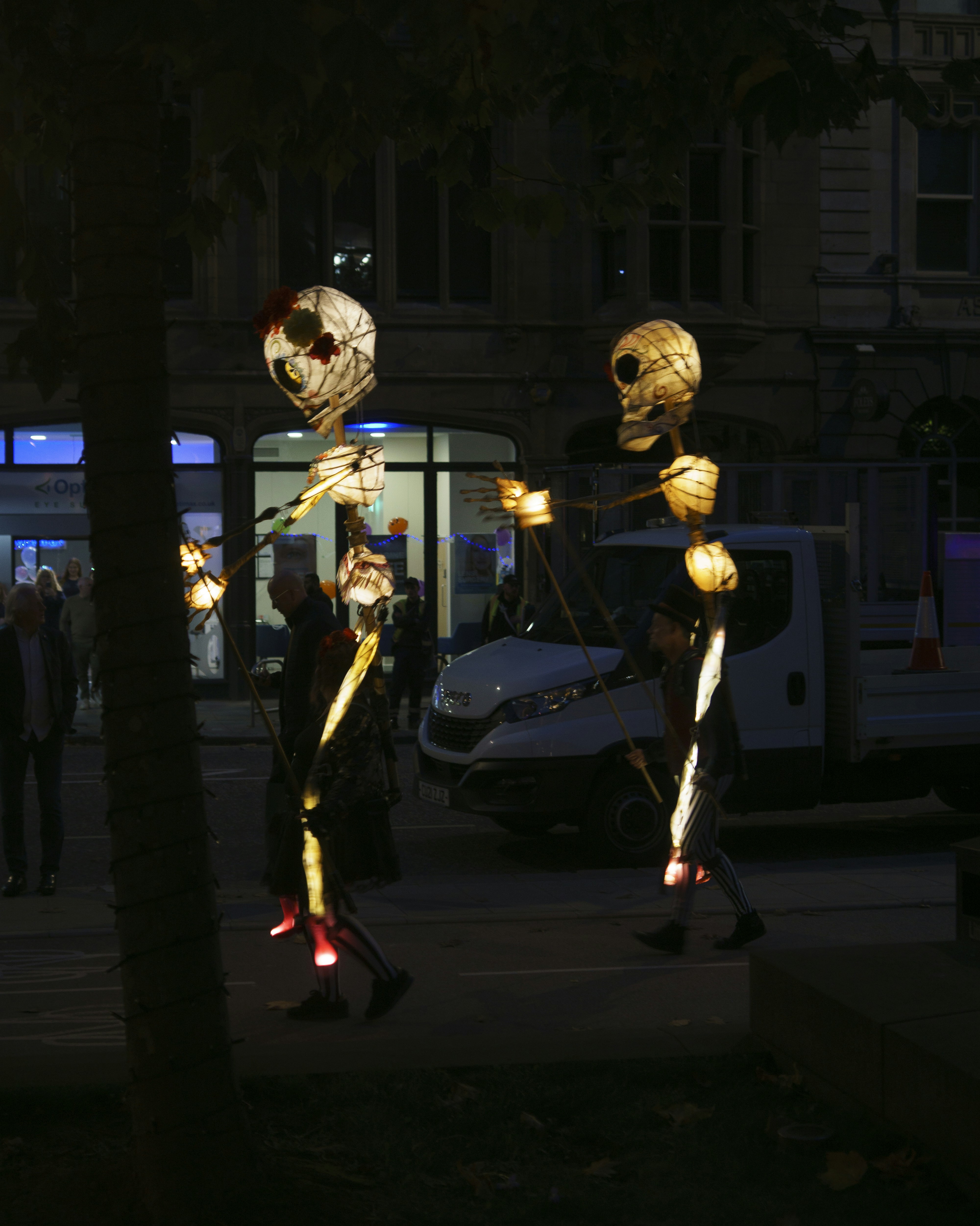 A couple of skeletons walking down a street photo – Free Car Image on ...