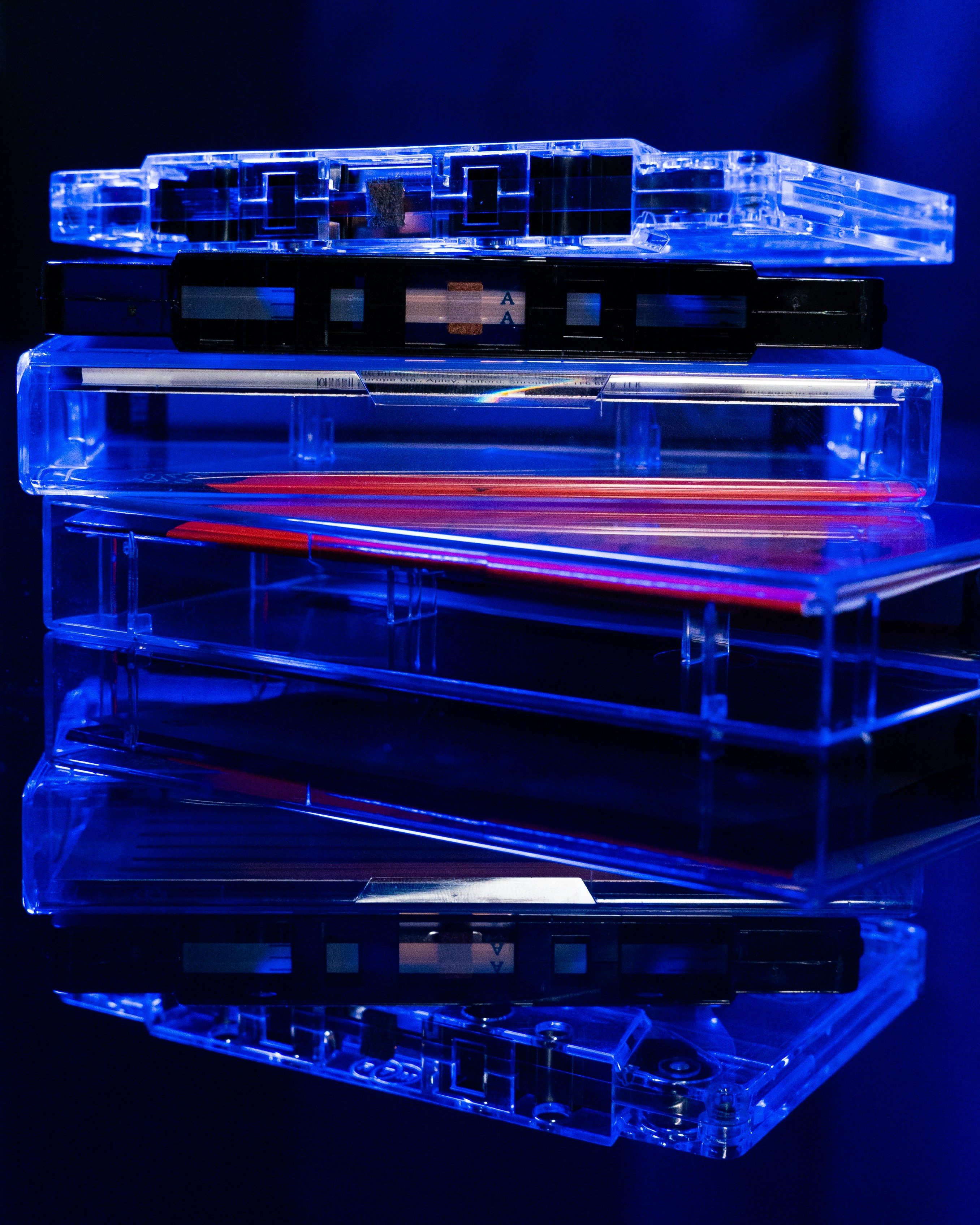 A stack of three clear cases sitting on top of a table photo – Free ...