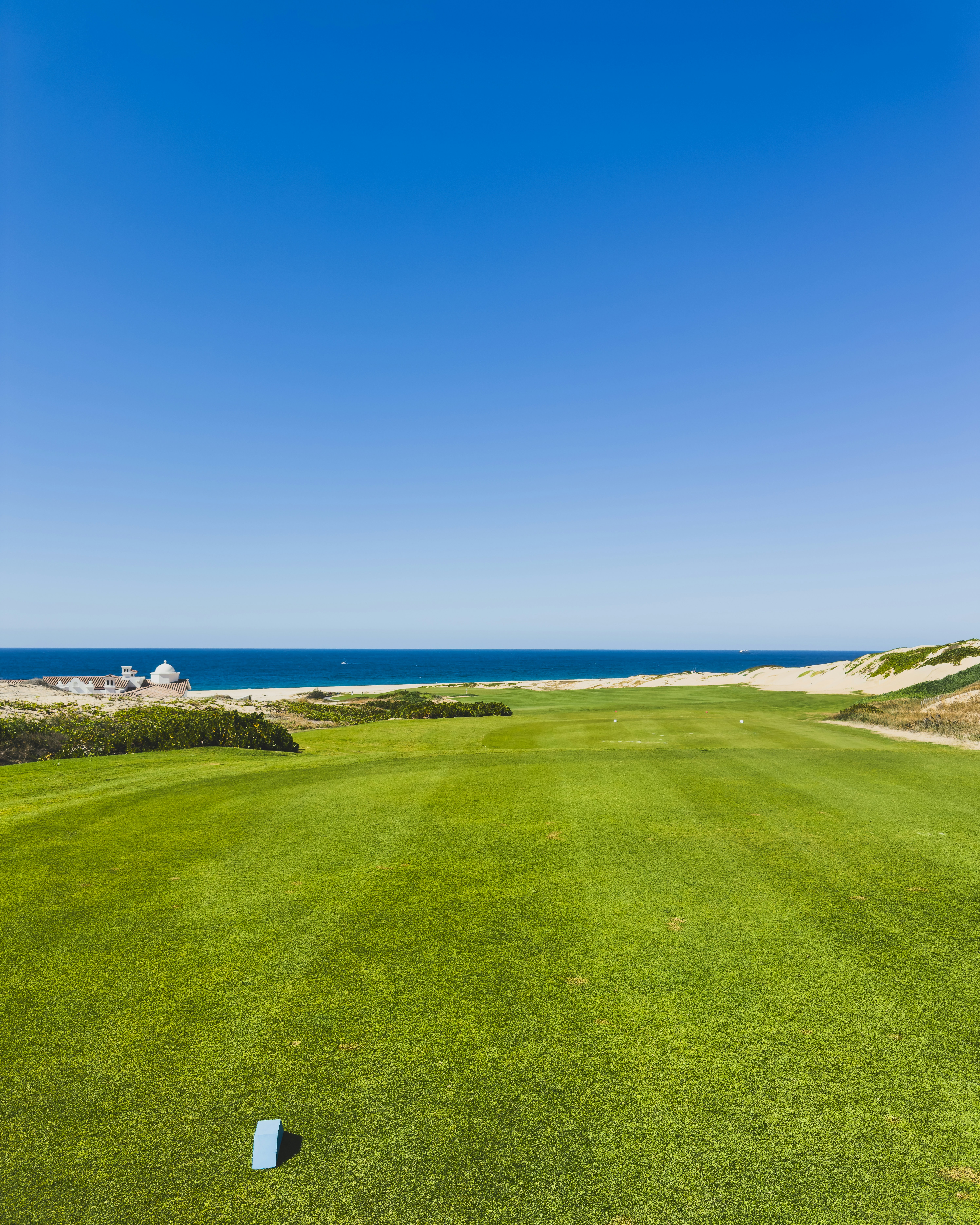 A view of a golf course with the ocean in the background photo – Free ...