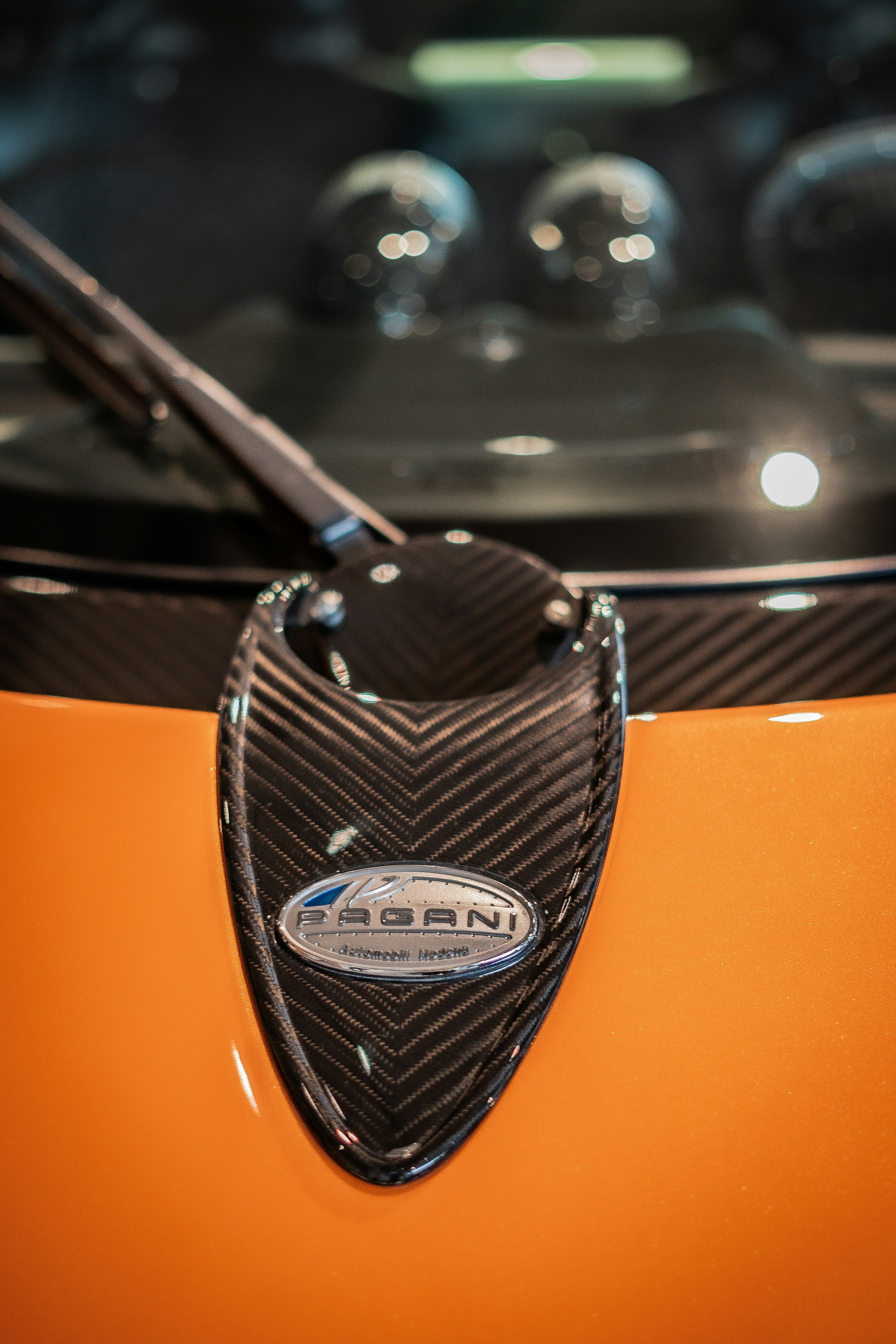 Carbon Fiber Crest: An Orange Classic Badge on the Hood