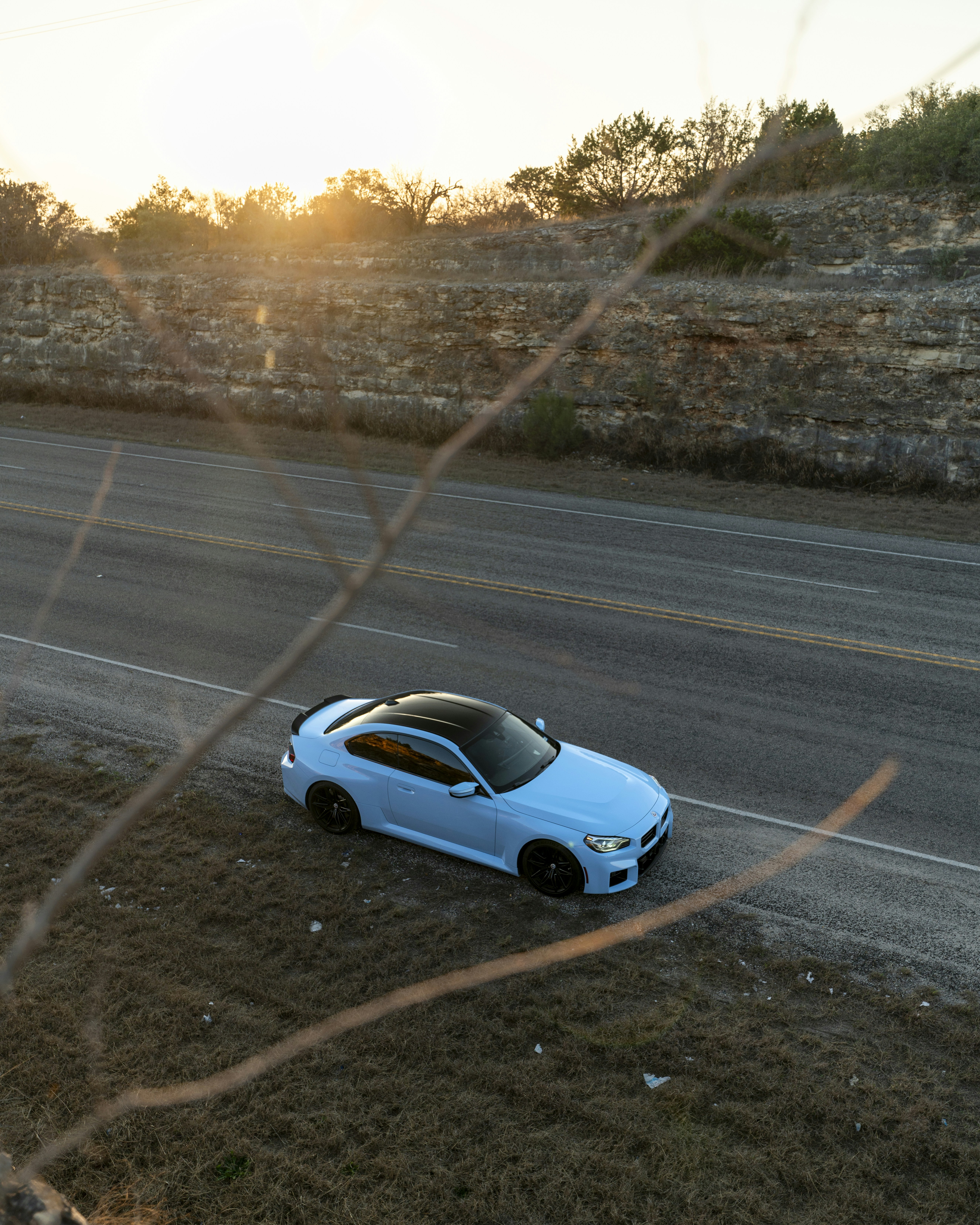 A blue car is parked on the side of the road photo – Free M2 comp Image ...