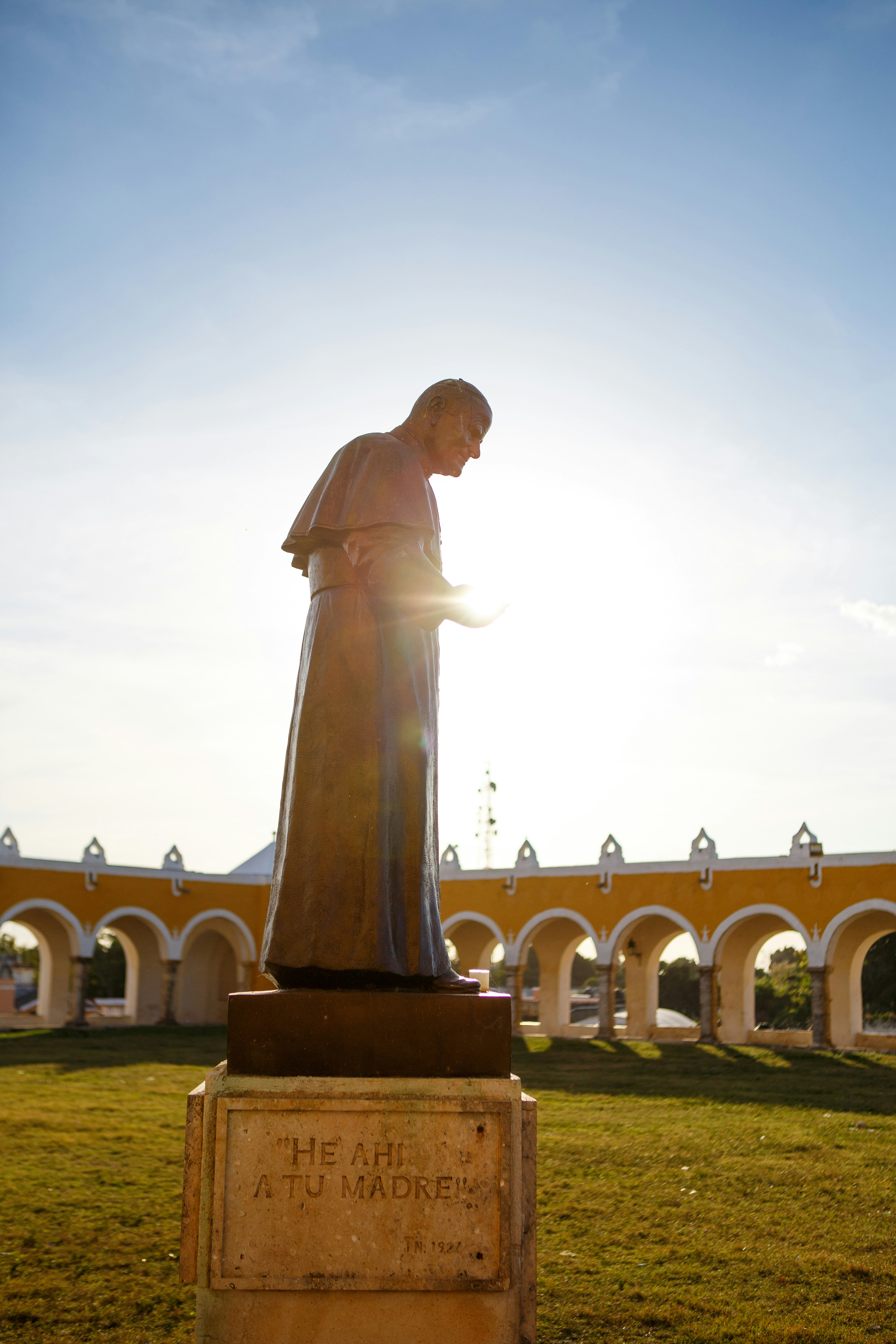 Sunlit Statue: Quiet Reverie in an Arcaded Courtyard