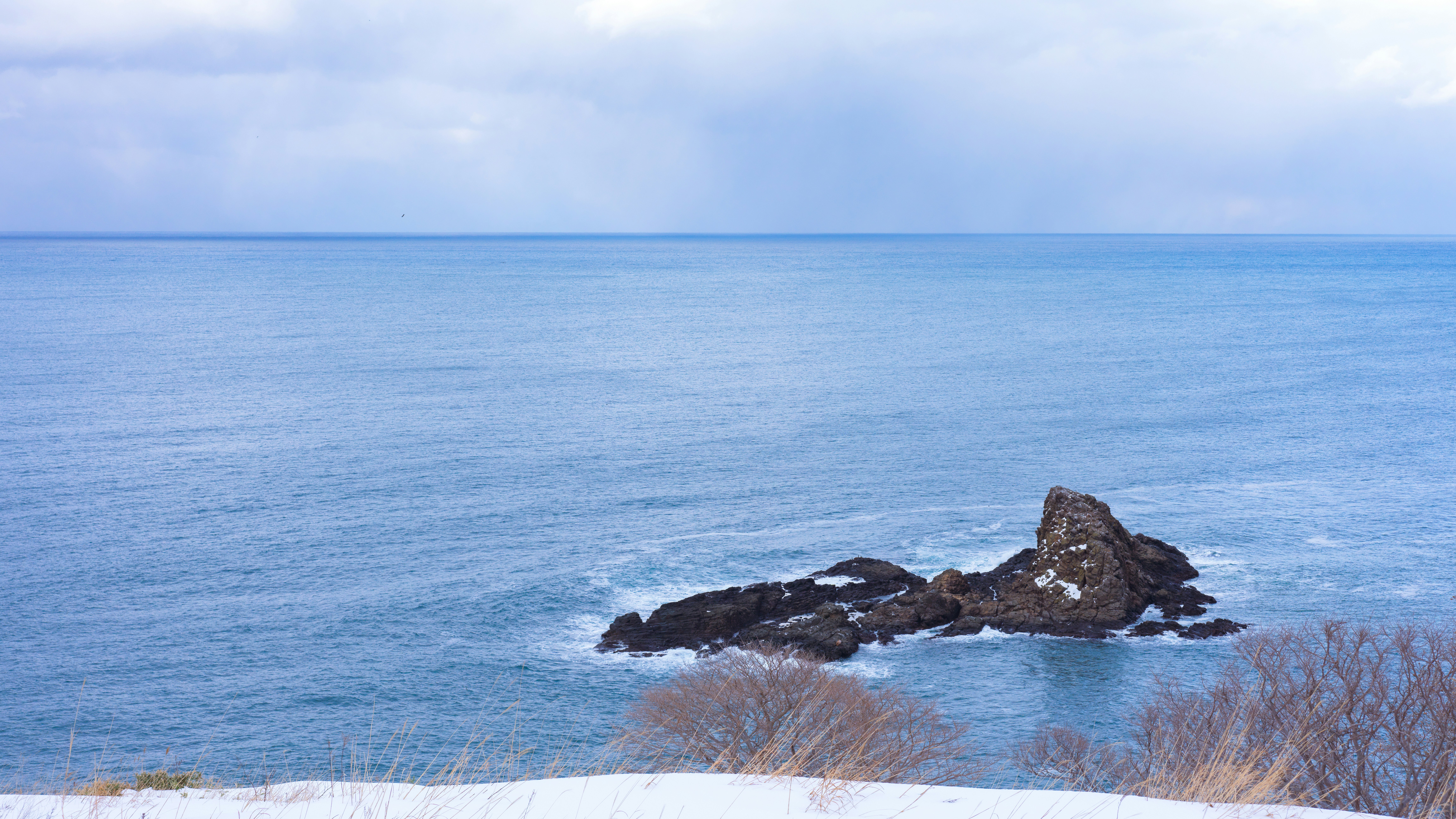 Stone Sentinel Over a Quiet Blue Sea