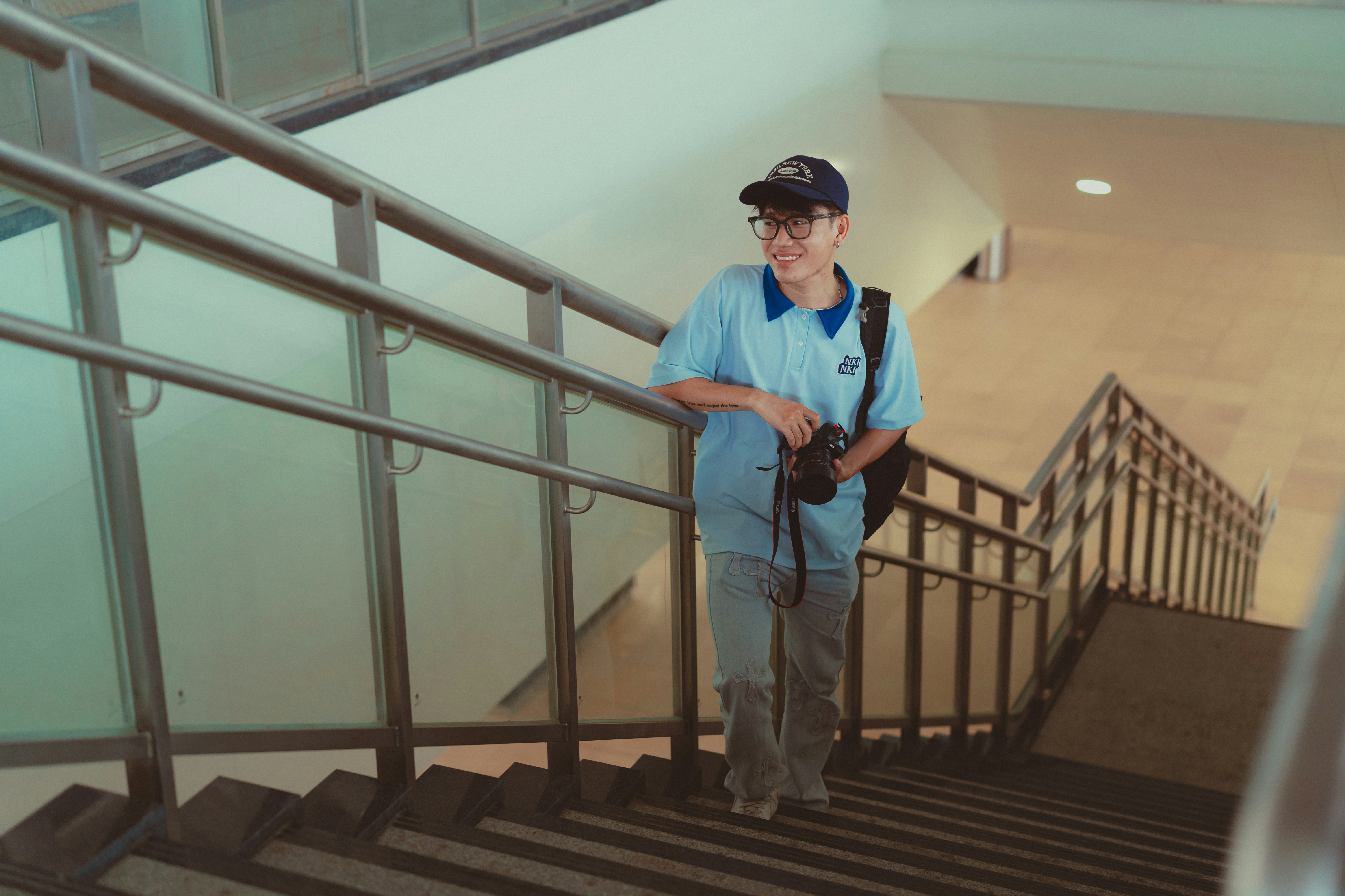Paused Pro at the Stairwell: A Photographer with a Lens on the Move