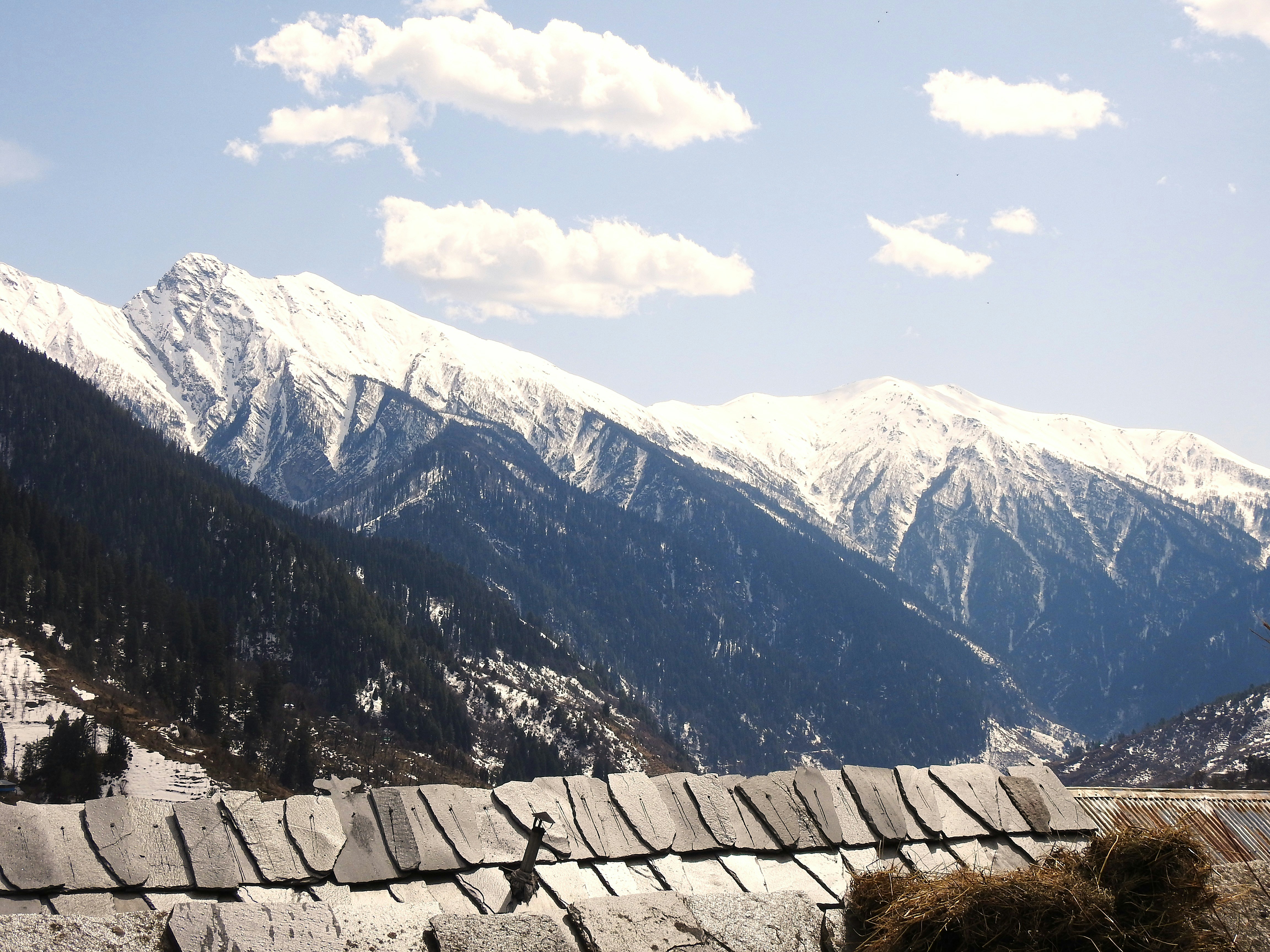 Snow-Capped Peaks Beyond the Rooftop