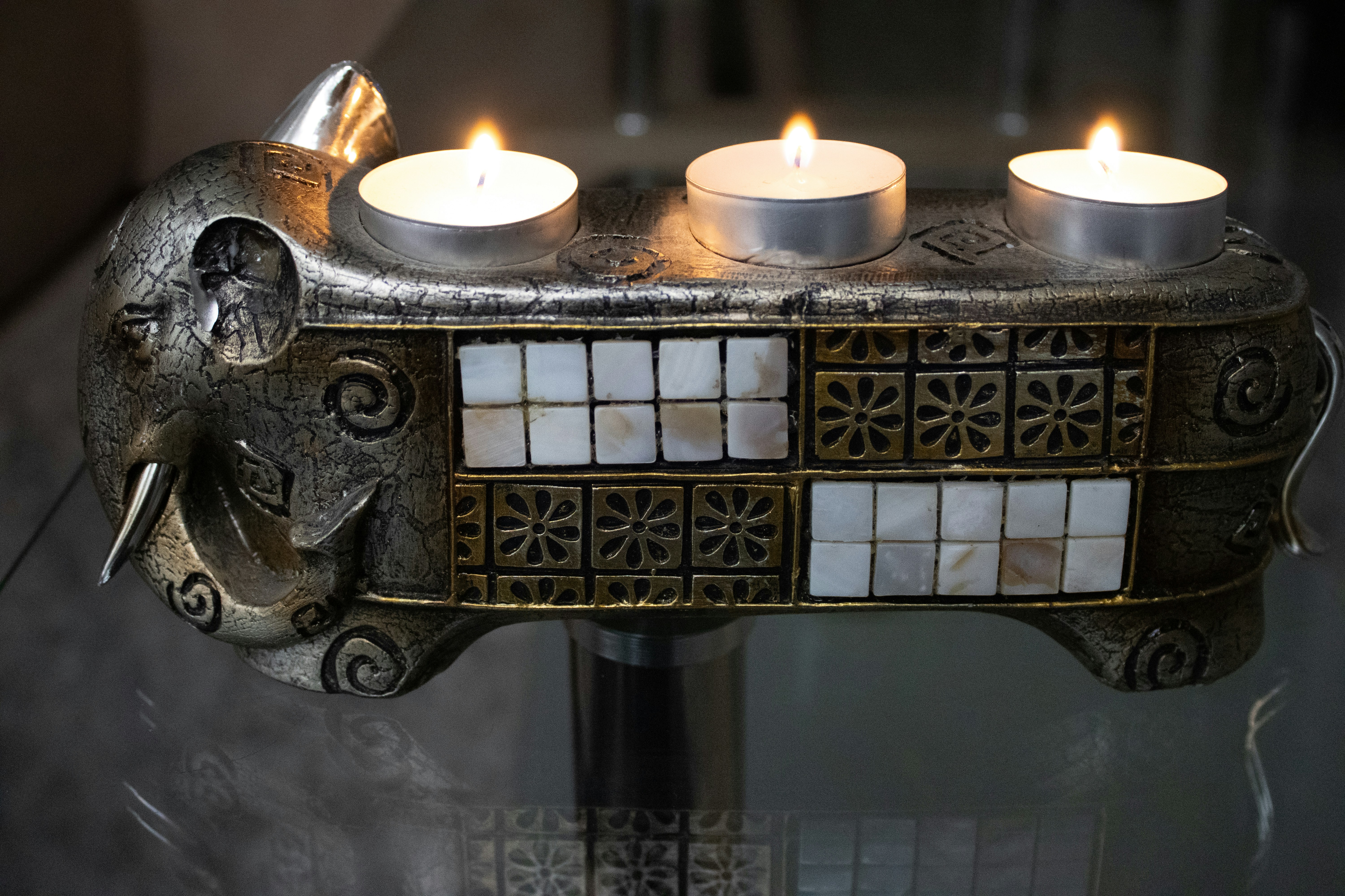 Three Tealights on a Mosaic Iron Candle Holder: Quiet Fire on Ornate Metalwork