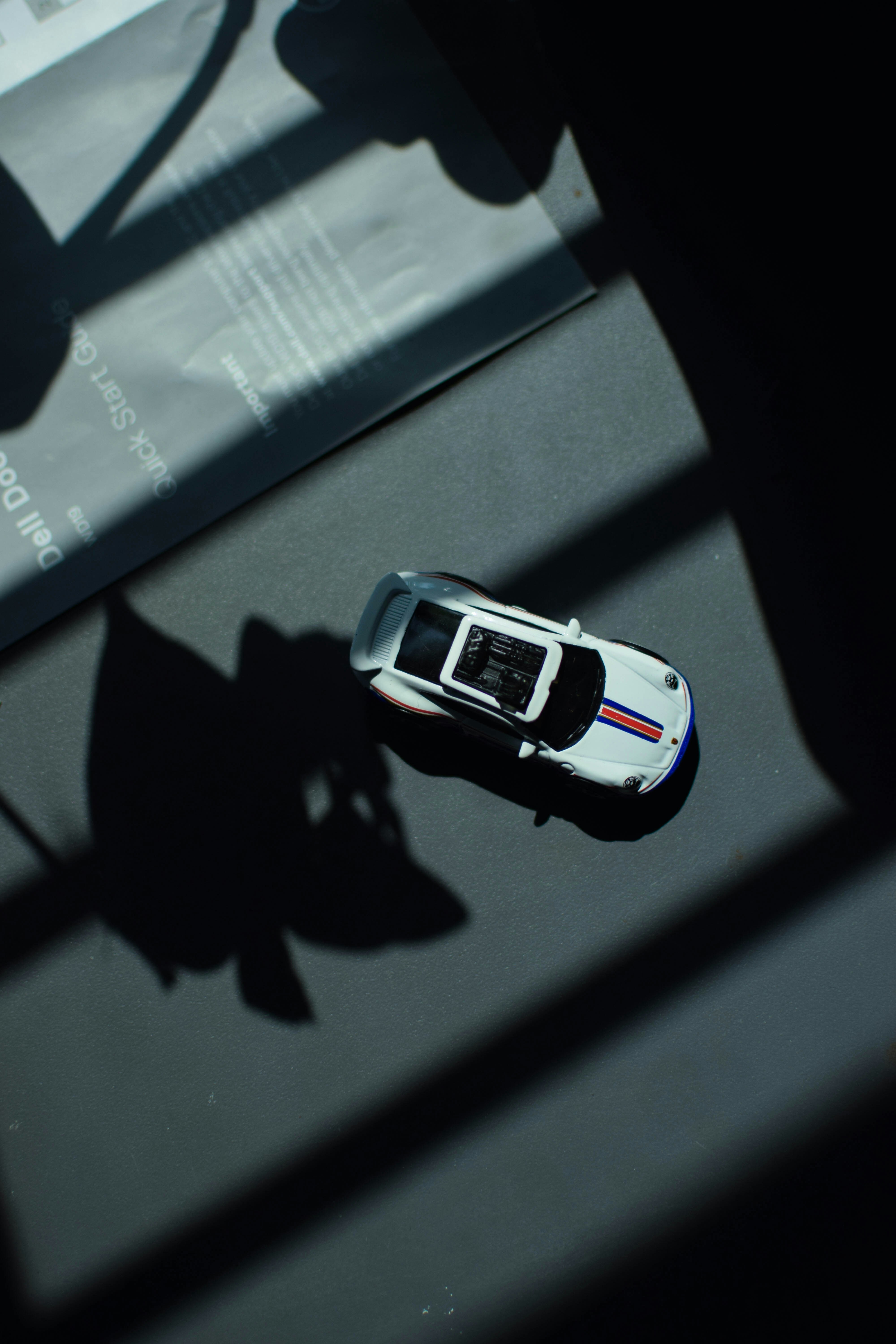 White Model Racer under Striped Shadows