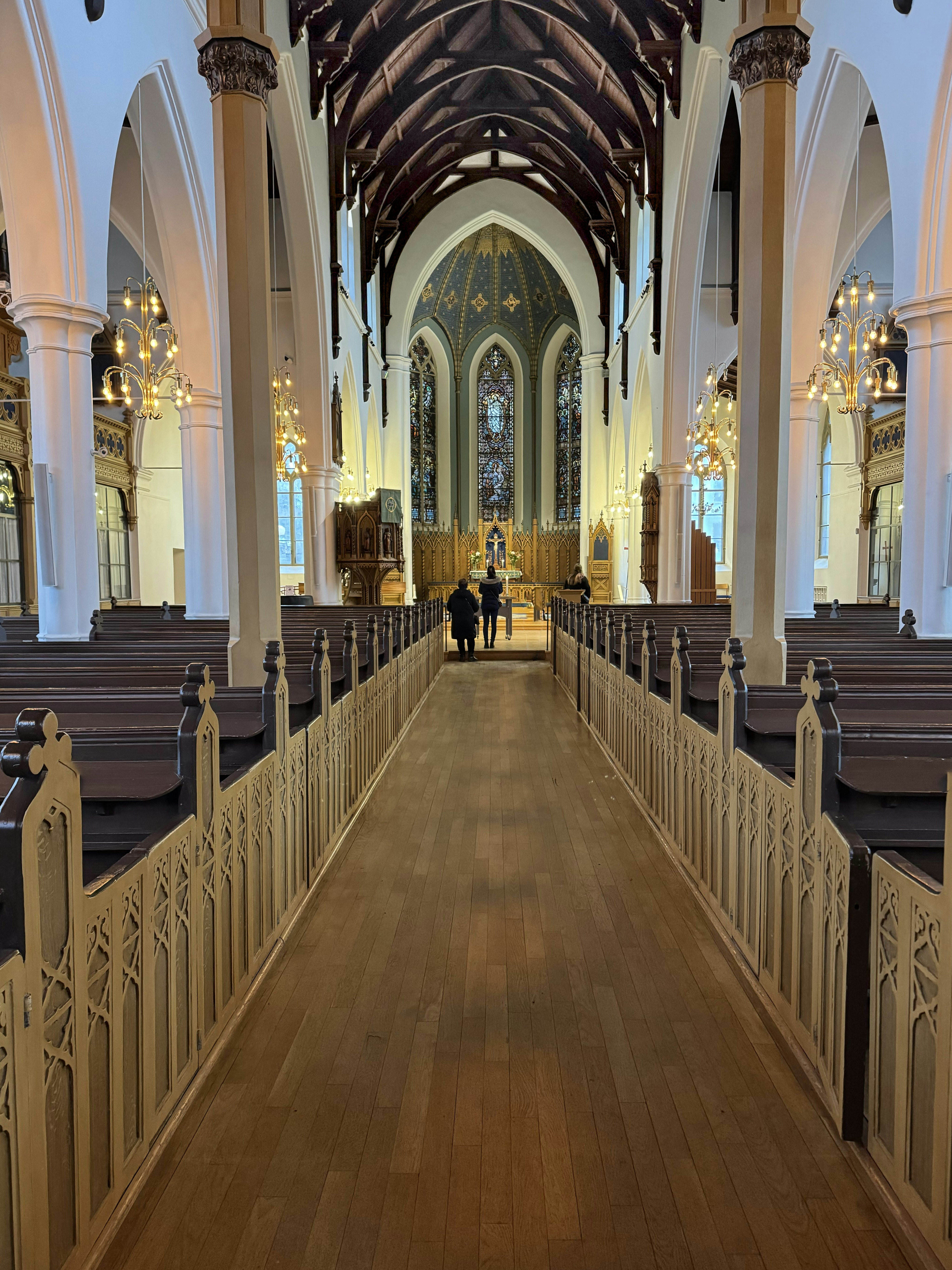 Aisle to Light: Central Nave Toward the Stained-Glass Altar