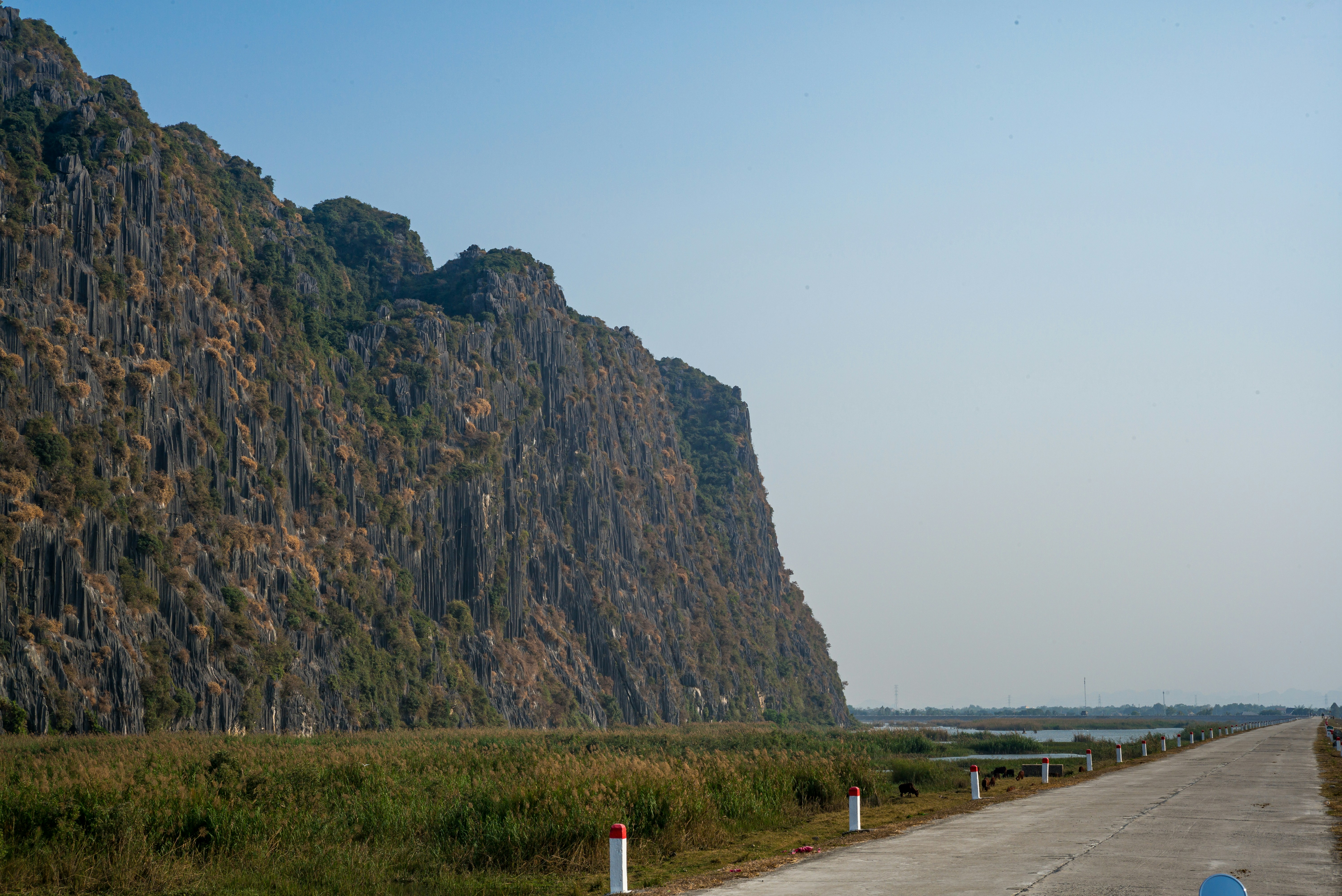 Cliffbound Roadscape: Granite Wall Framing the Open Horizon