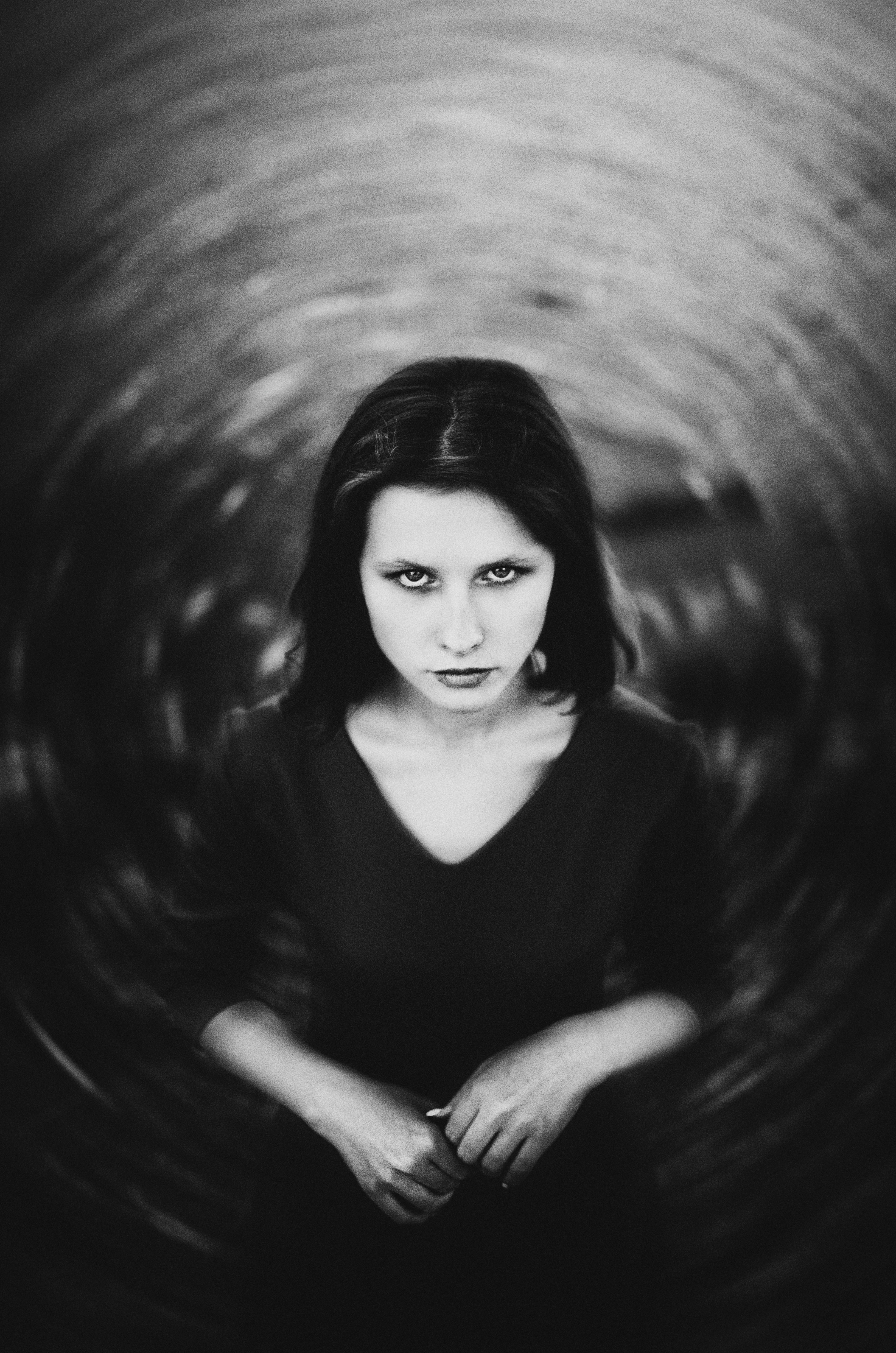 A woman sitting in front of a metal object photo – Free Portrait Image ...