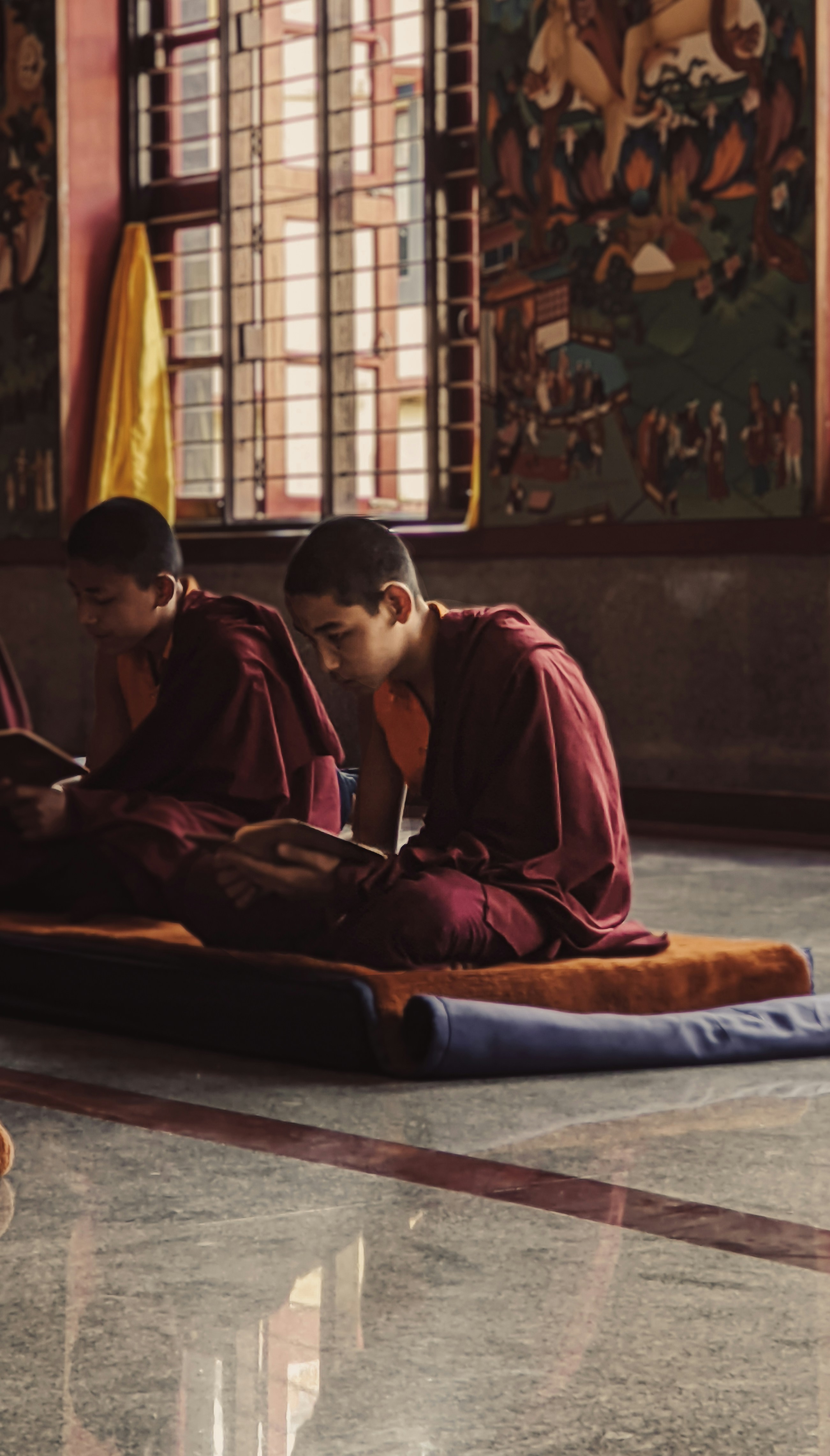 Quiet Reading in a Temple: Monks in Maroon by Sunlit Window