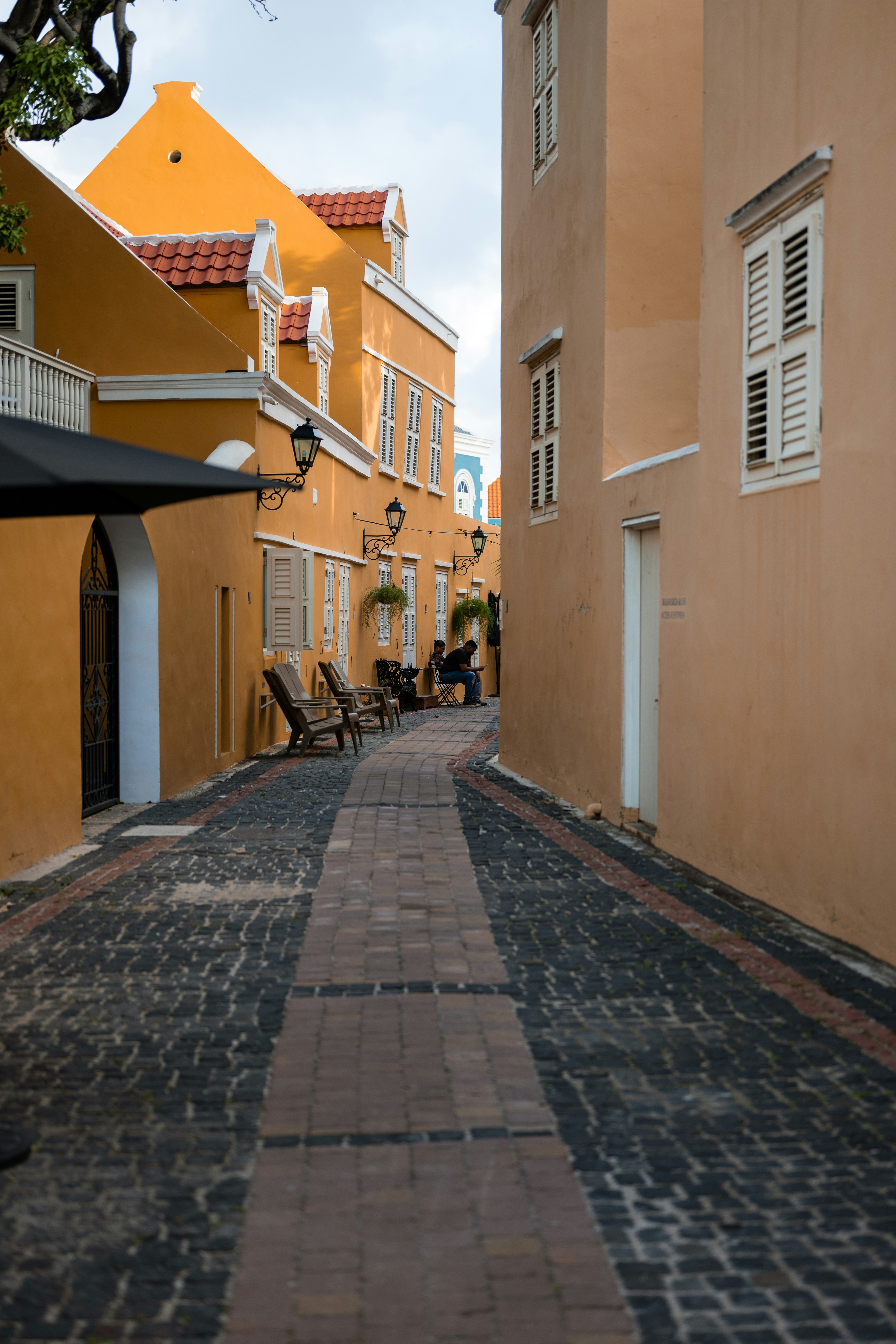 Ochre Lane: Sunlit Cobblestones and Quiet Conversation