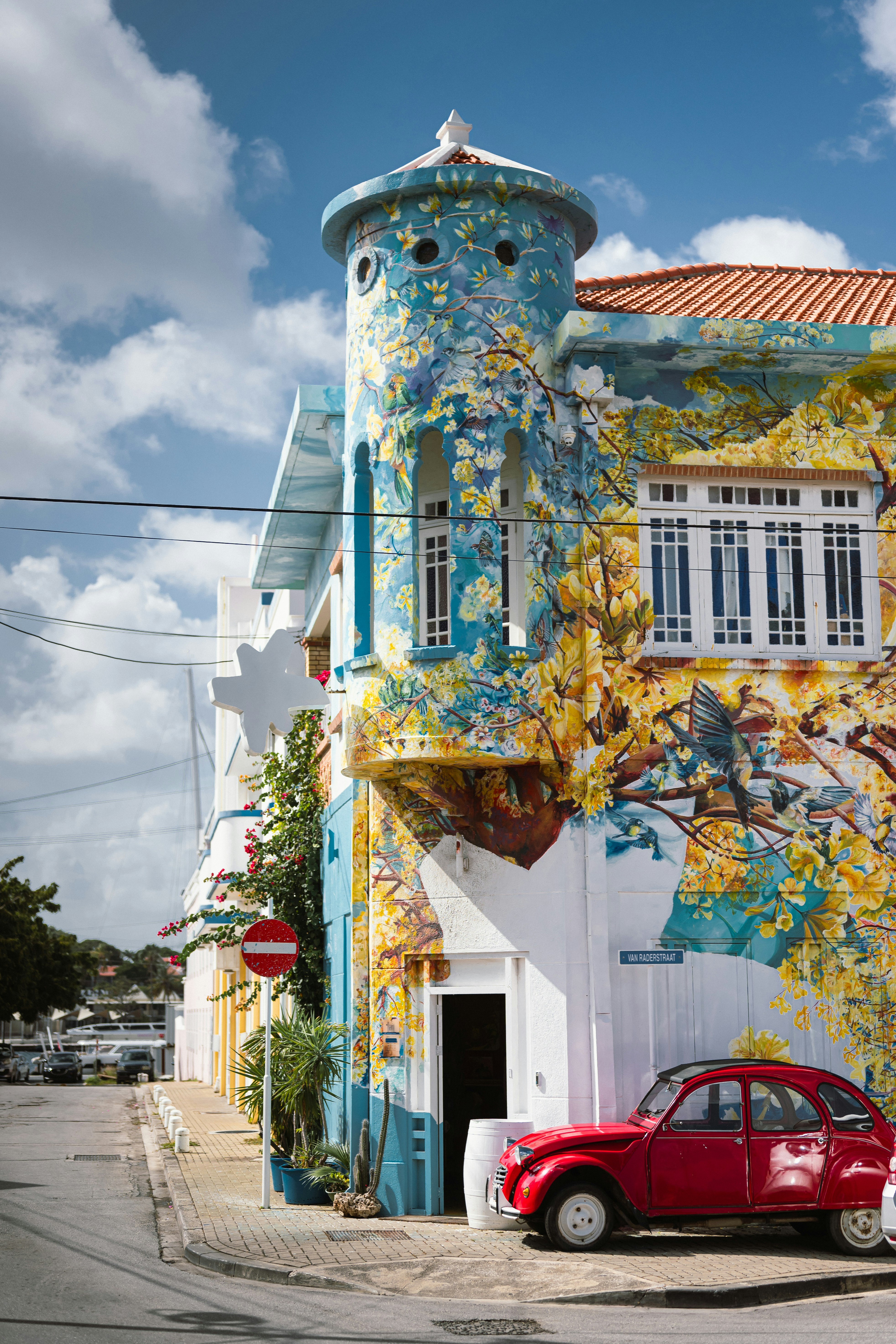 Floral Turreted Facade on a Muraled Street with a Ruby Beetle
