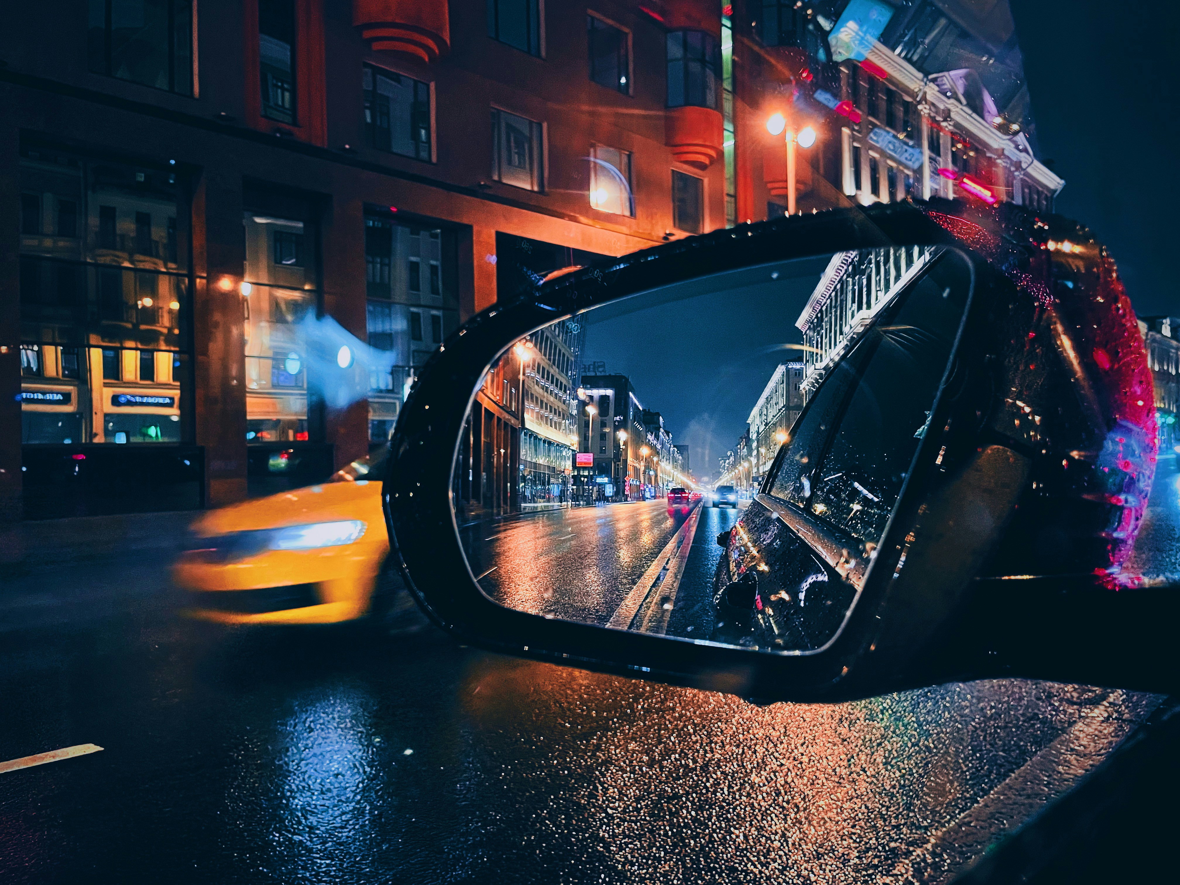 City lights. Moscow. Tverskaya street. | A rear view mirror of a car on a city street