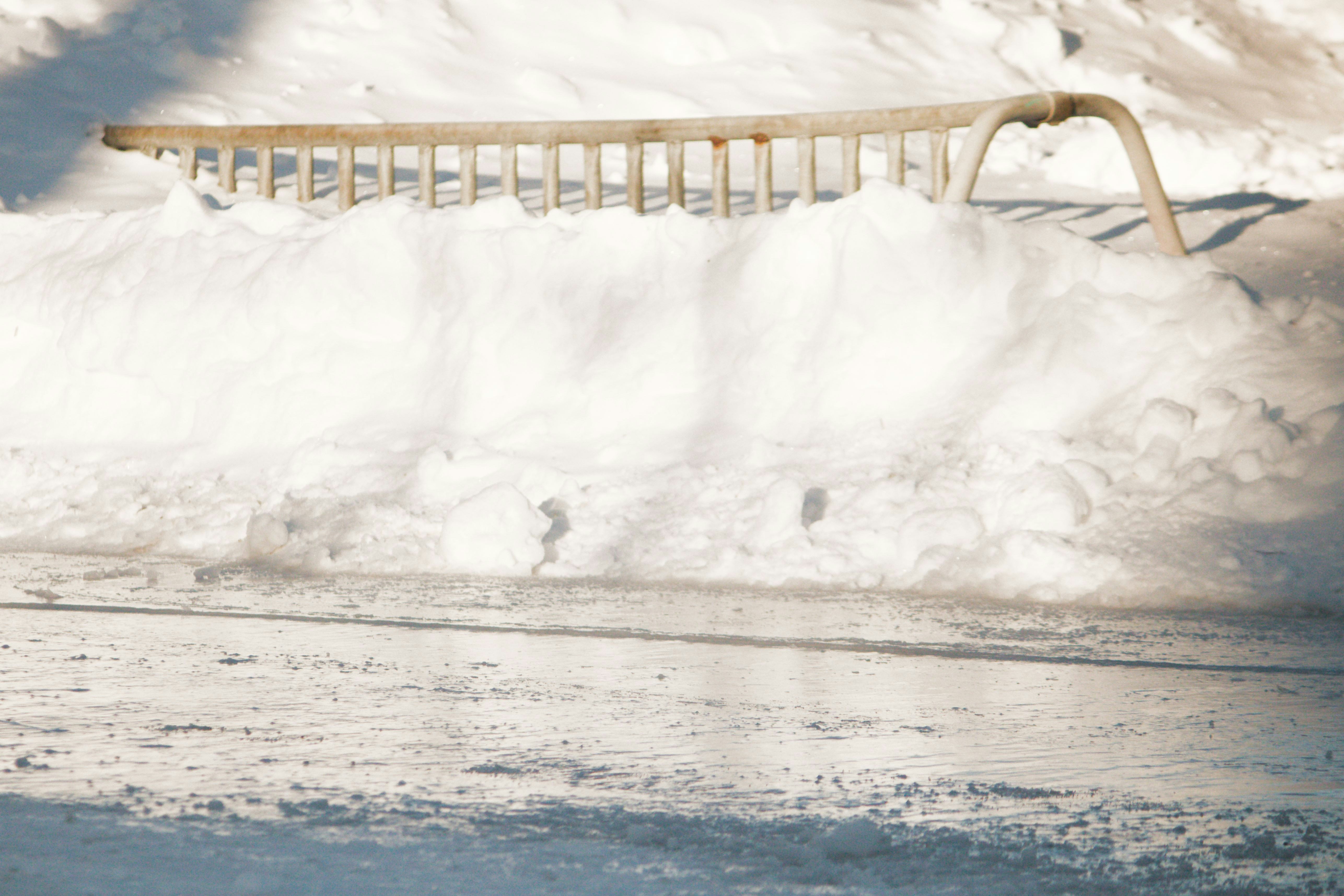 A man riding a snowboard down a snow covered slope photo – Free ...