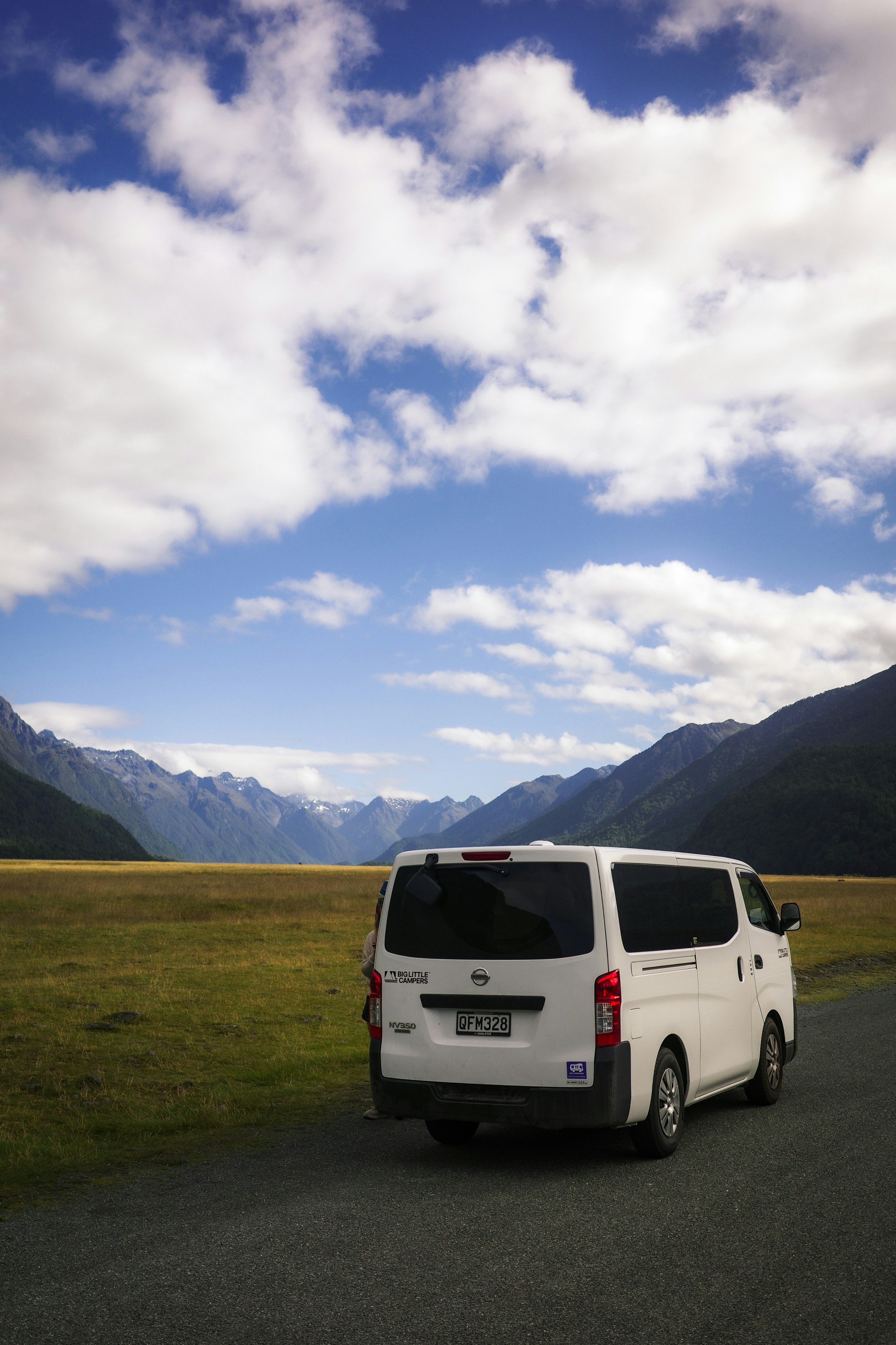 Alpine Roadside: White Van at the Edge of the Open Sky
