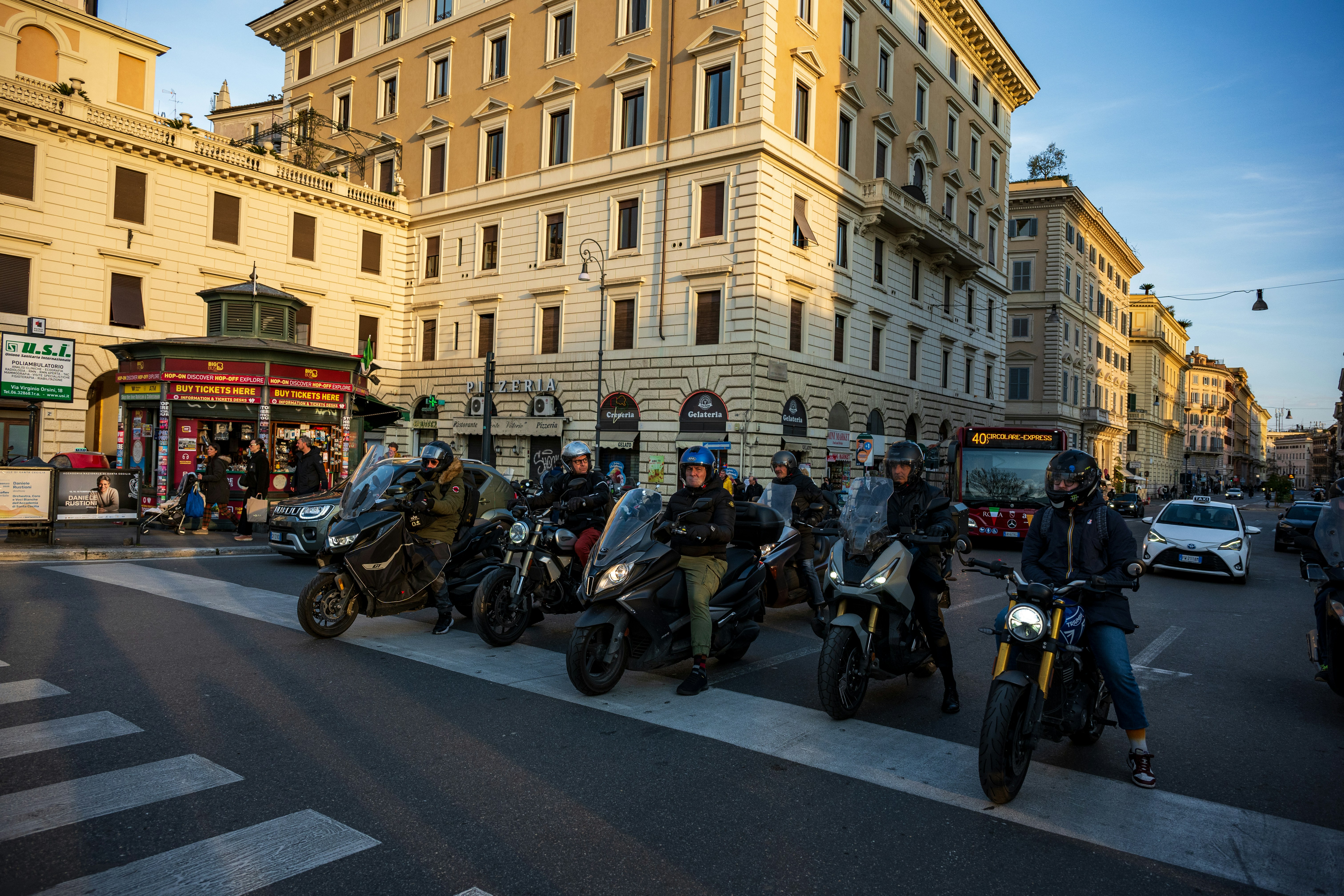 A group of people riding motorcycles down a street photo – Free Car ...